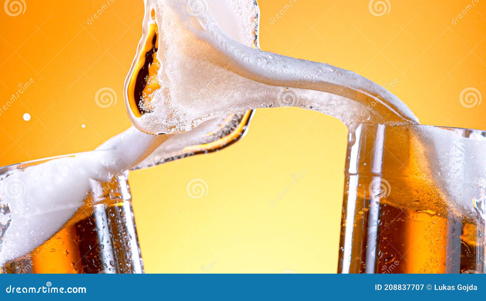 Two Glasses of Beer Toasting Creating Splash. Stock Image - Image of ...