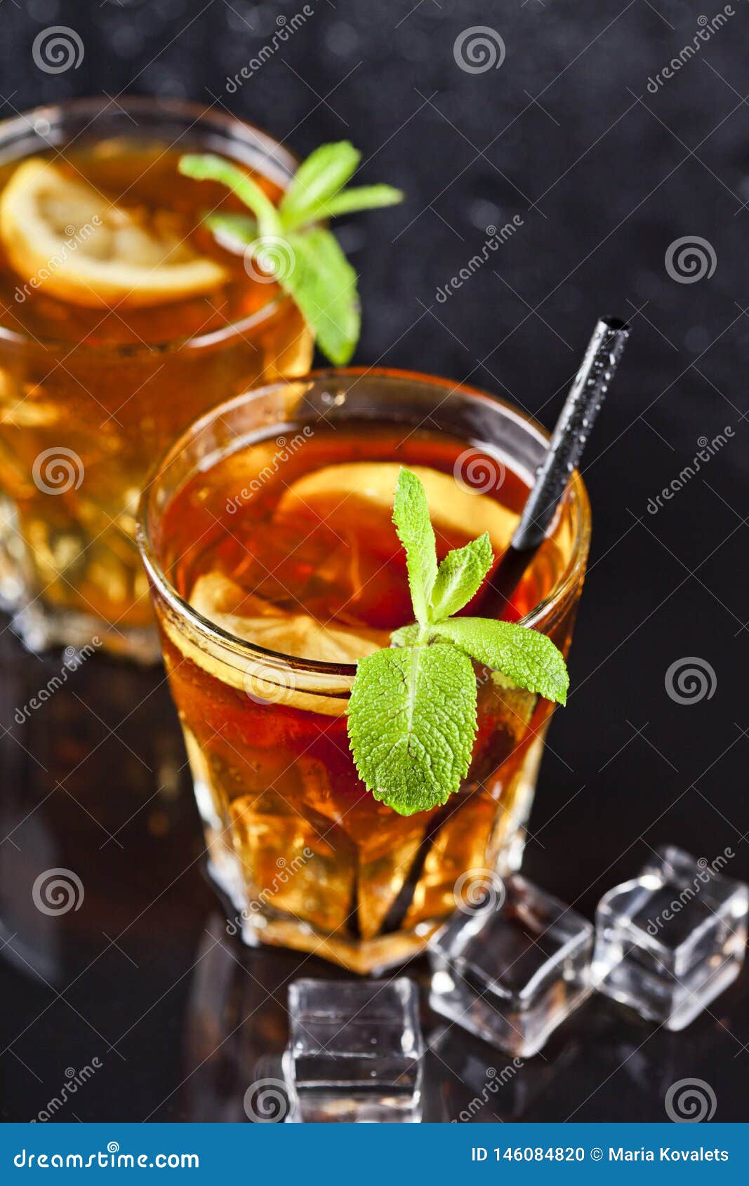 Two Glasses With Cold Traditional Iced Tea With Lemon Mint Leaves And
