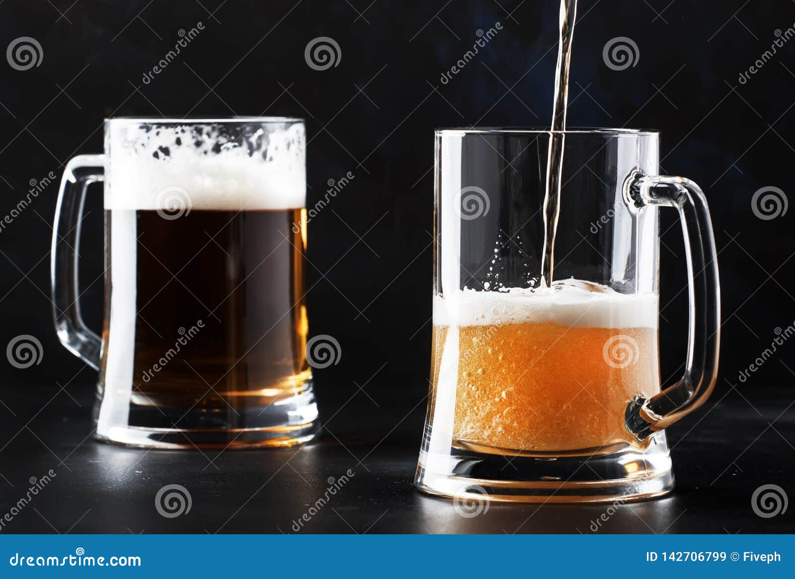 Two Glasses of German Light Beer, Beer Poured into Mug, Dark Bar ...