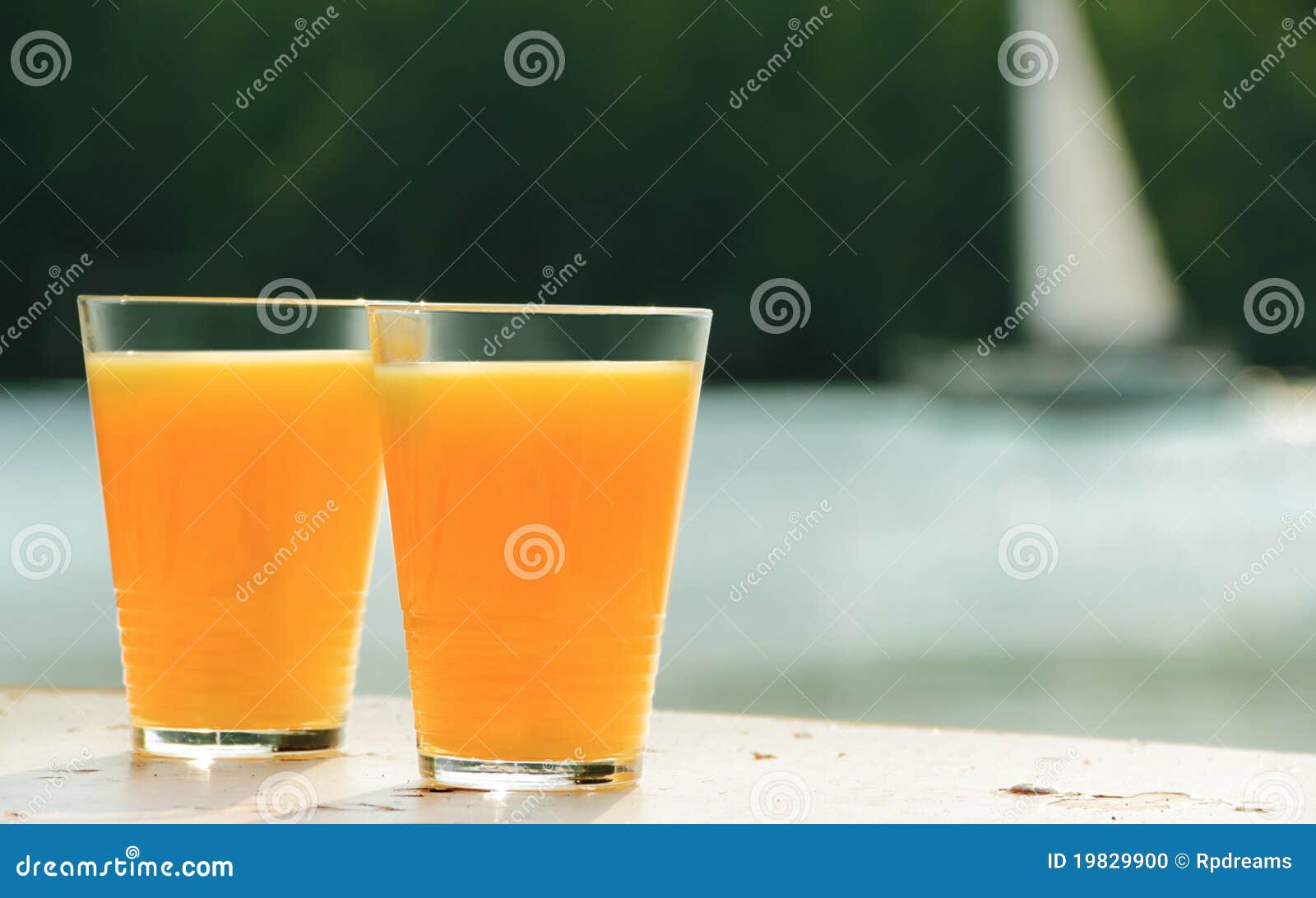 Two Glasses of Orange Juice Against Sea Stock Photo - Image of closeup ...