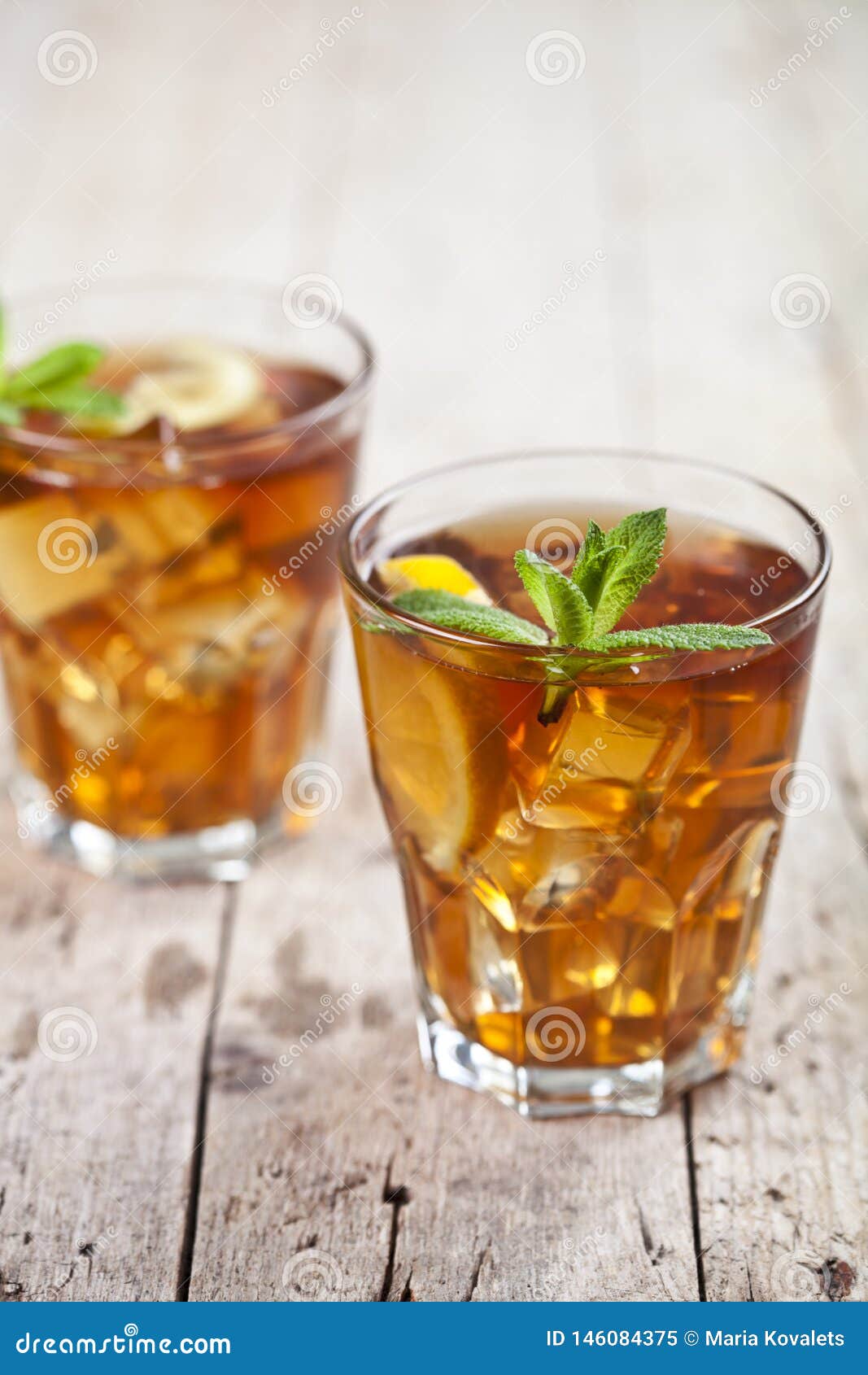 Two Glasses With Traditional Iced Tea With Lemon Mint Leaves And Ice