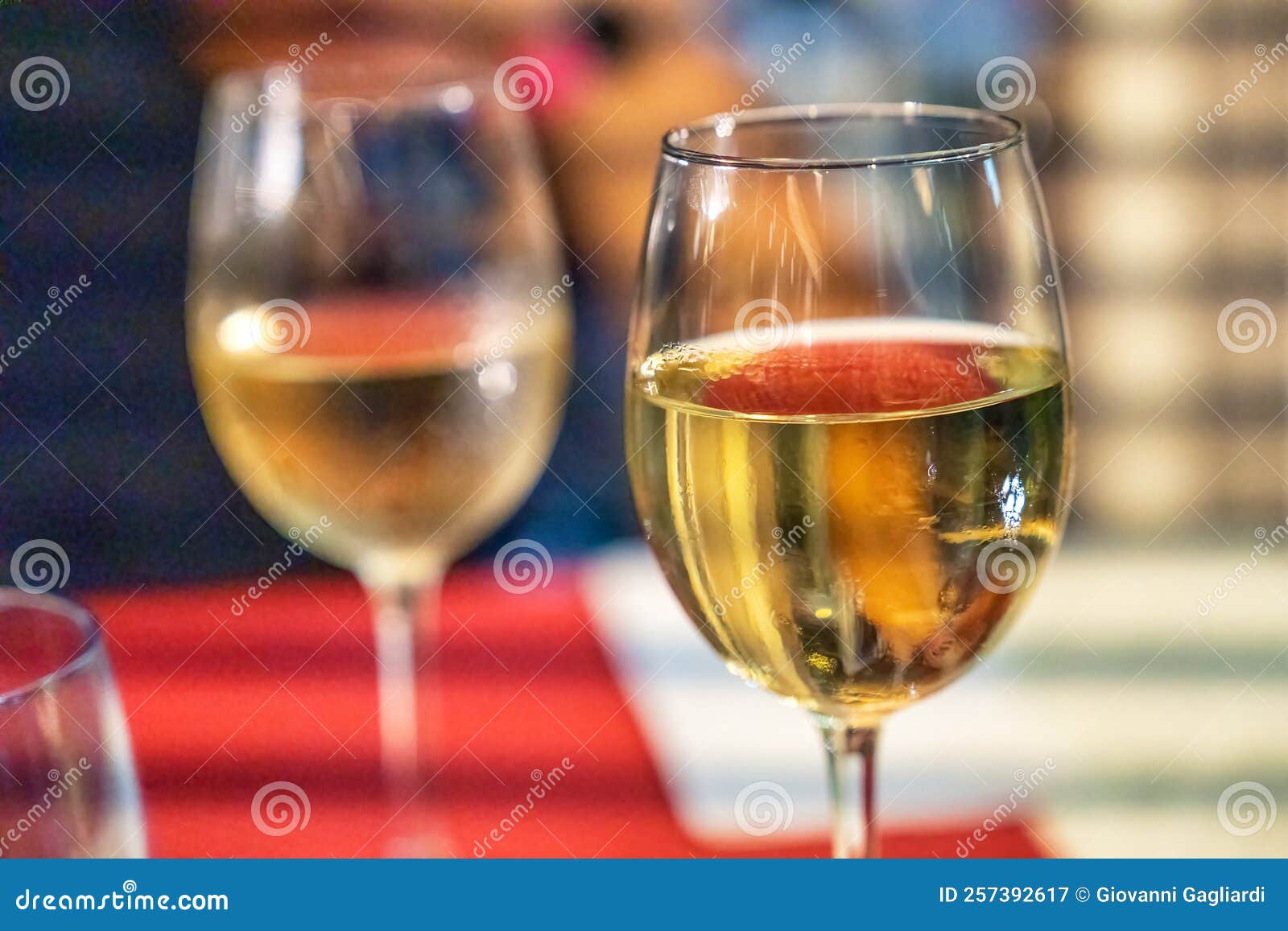 Two Glasses of White Wine Standing Side by Side in a Close Up View Over ...