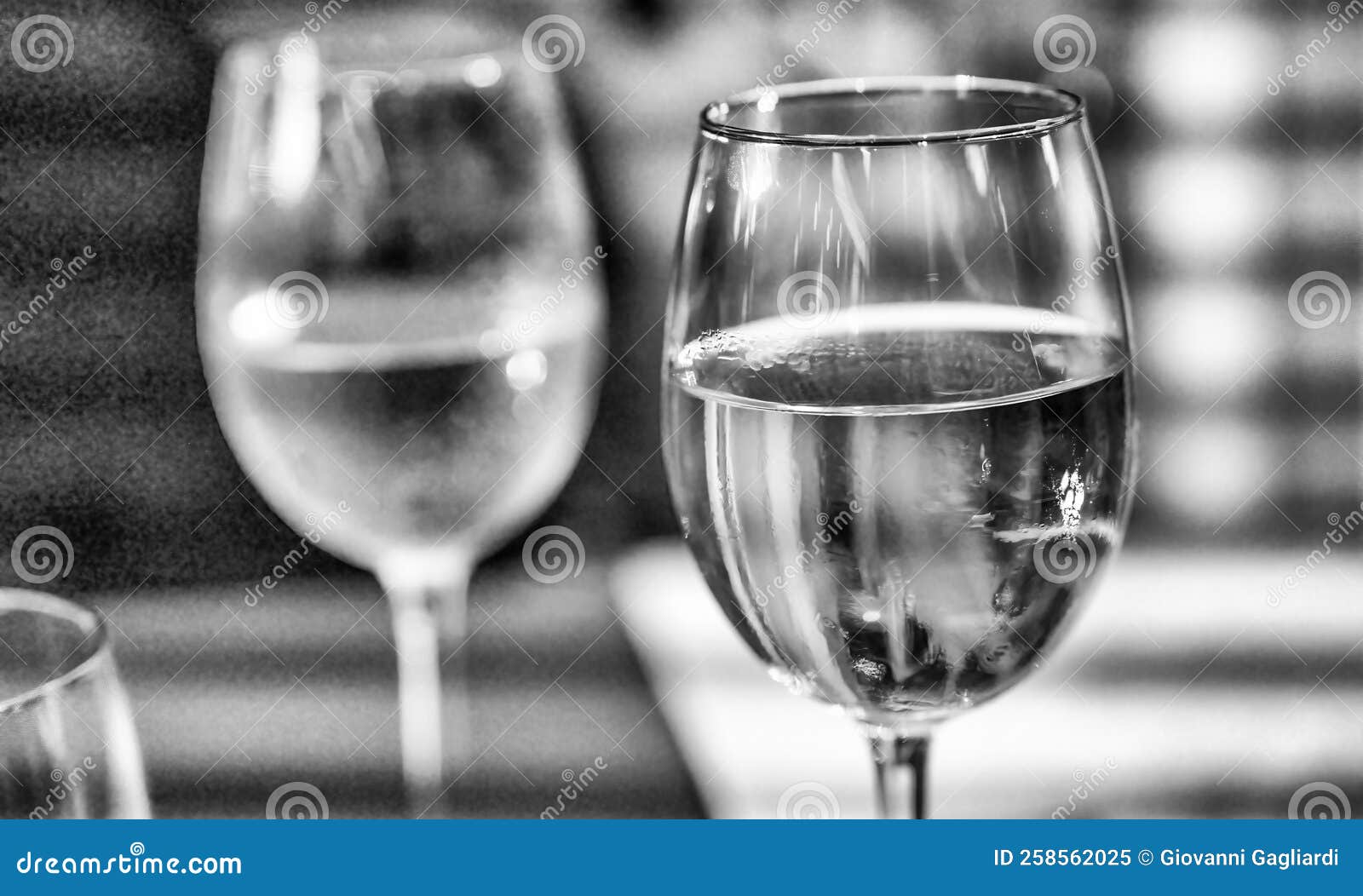 Two Glasses of White Wine Standing Side by Side in a Close Up View Over ...