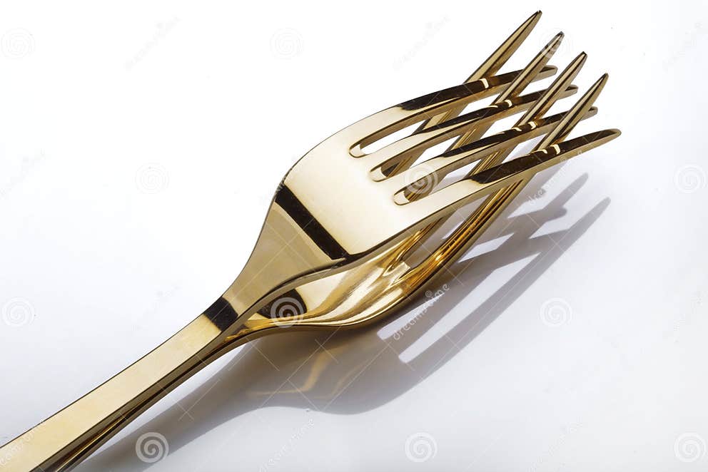 Two gold forks isolated stock photo. Image of gold, food - 18335660