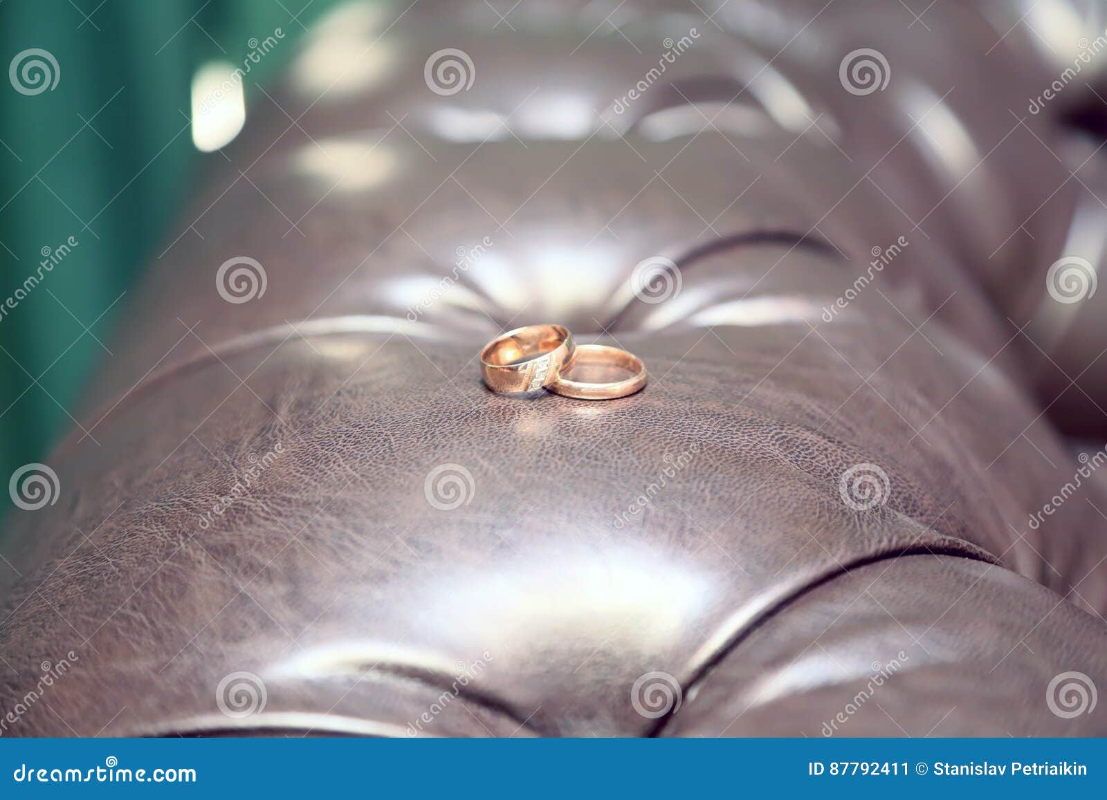Two Gold Rings on the Leather Sofa Stock Image - Image of celebration ...