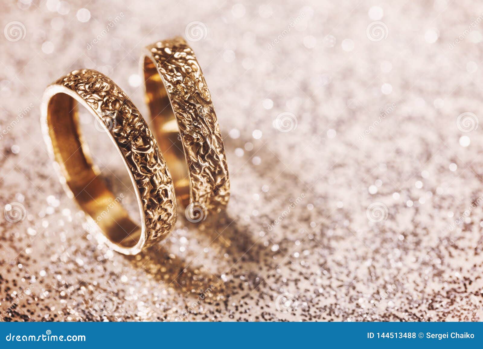 Two Gold Wedding Rings on Abstract Background with Copy Space Stock ...