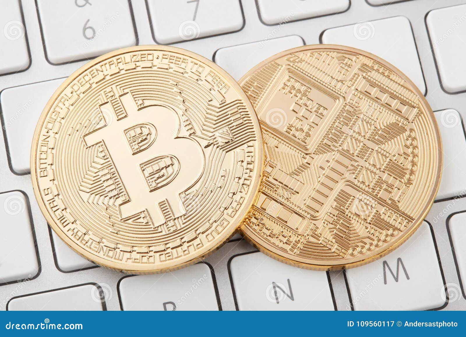 Two Golden Bitcoin Front and Back on Computer Keyboard Editorial ...