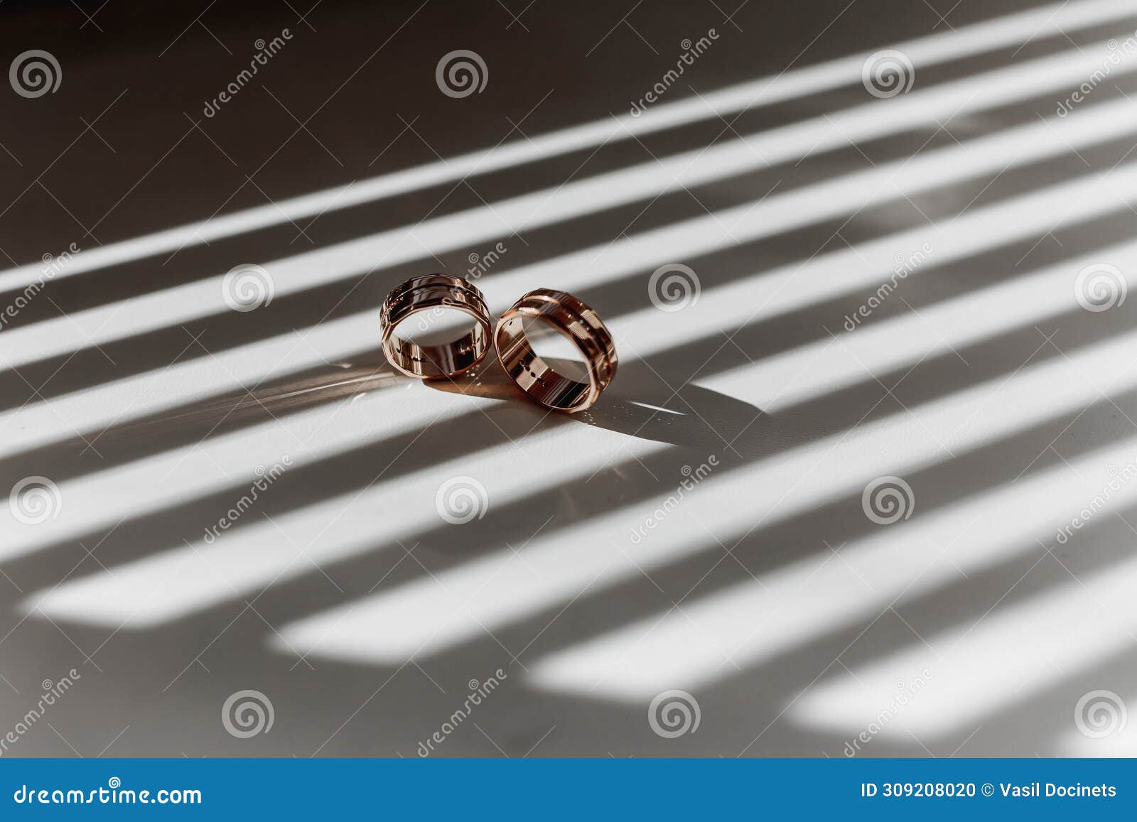 Two Golden Textured Wedding Rings on Rays of Falling Light Stock Photo ...