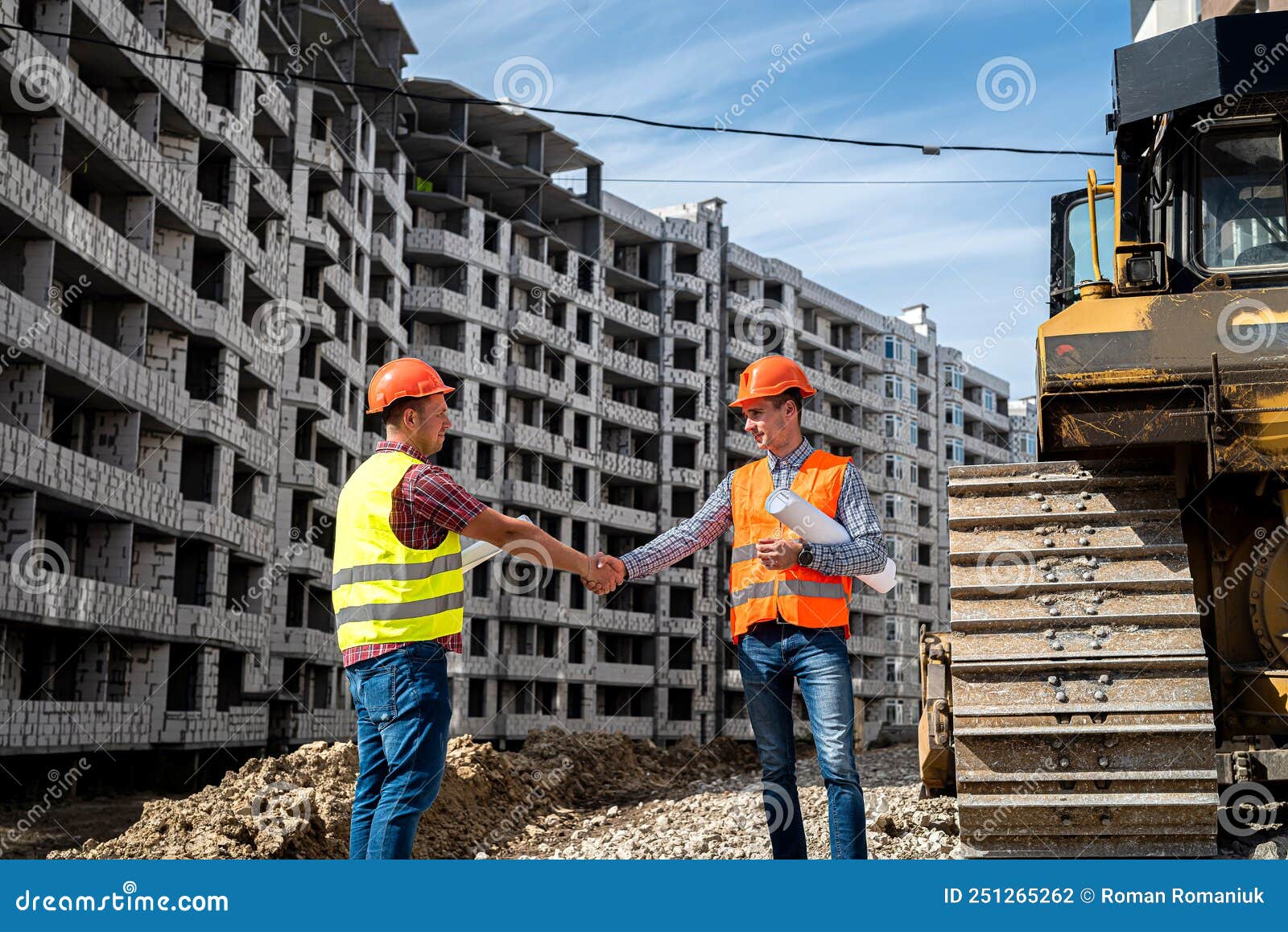 Two Good Workers in Uniform Shake Hands Near the Grader and the New ...