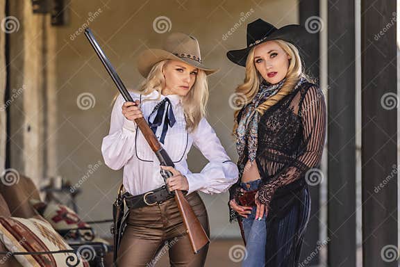 Two Lovely Blonde Models Dressed As Cowgirls Enjoys The American West