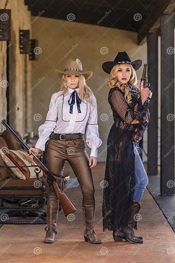 Two Lovely Blonde Models Dressed As Cowgirls Enjoys The American West