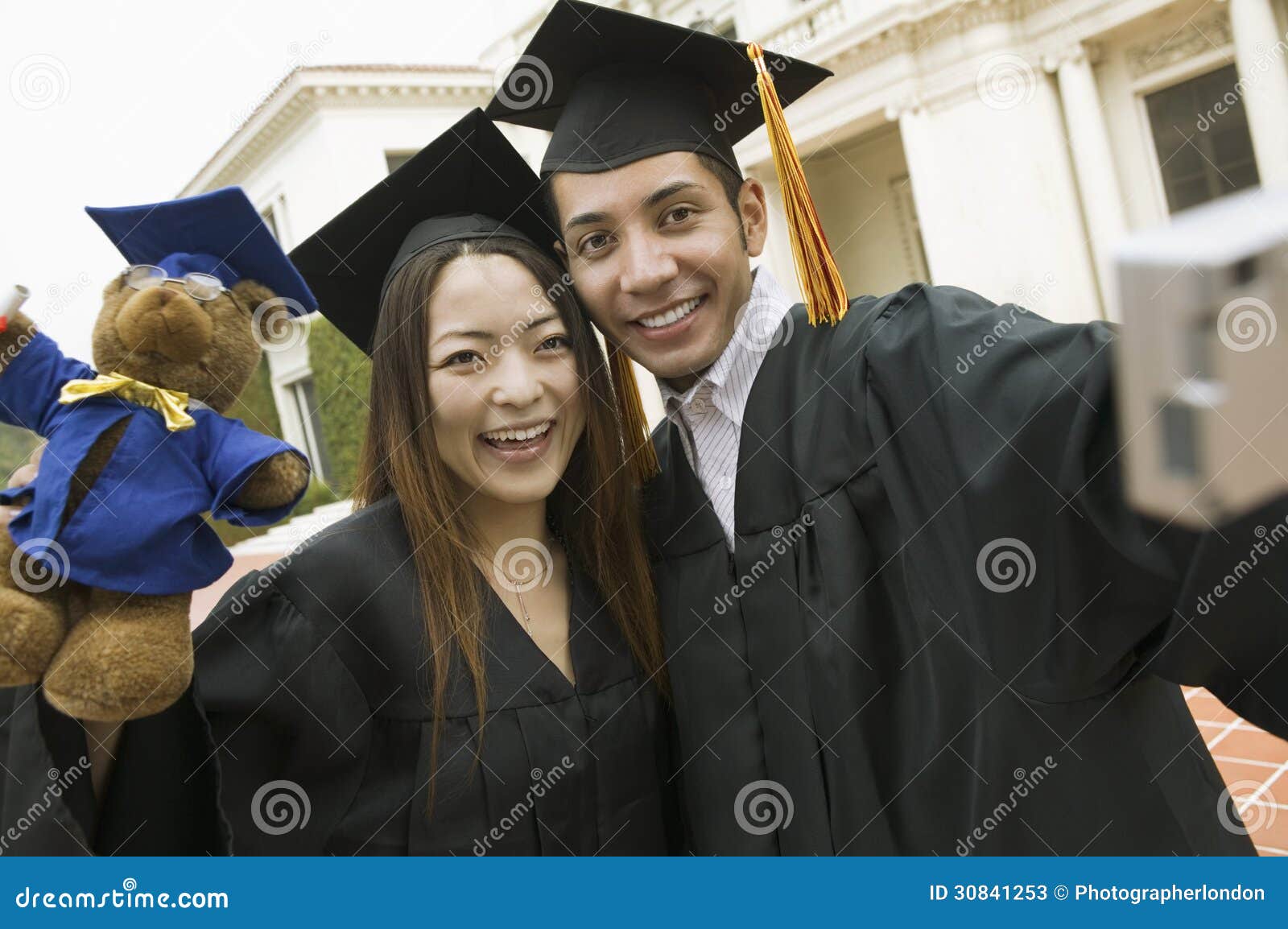 Two Graduates Taking Picture of Selves Outside Stock Image - Image of ...
