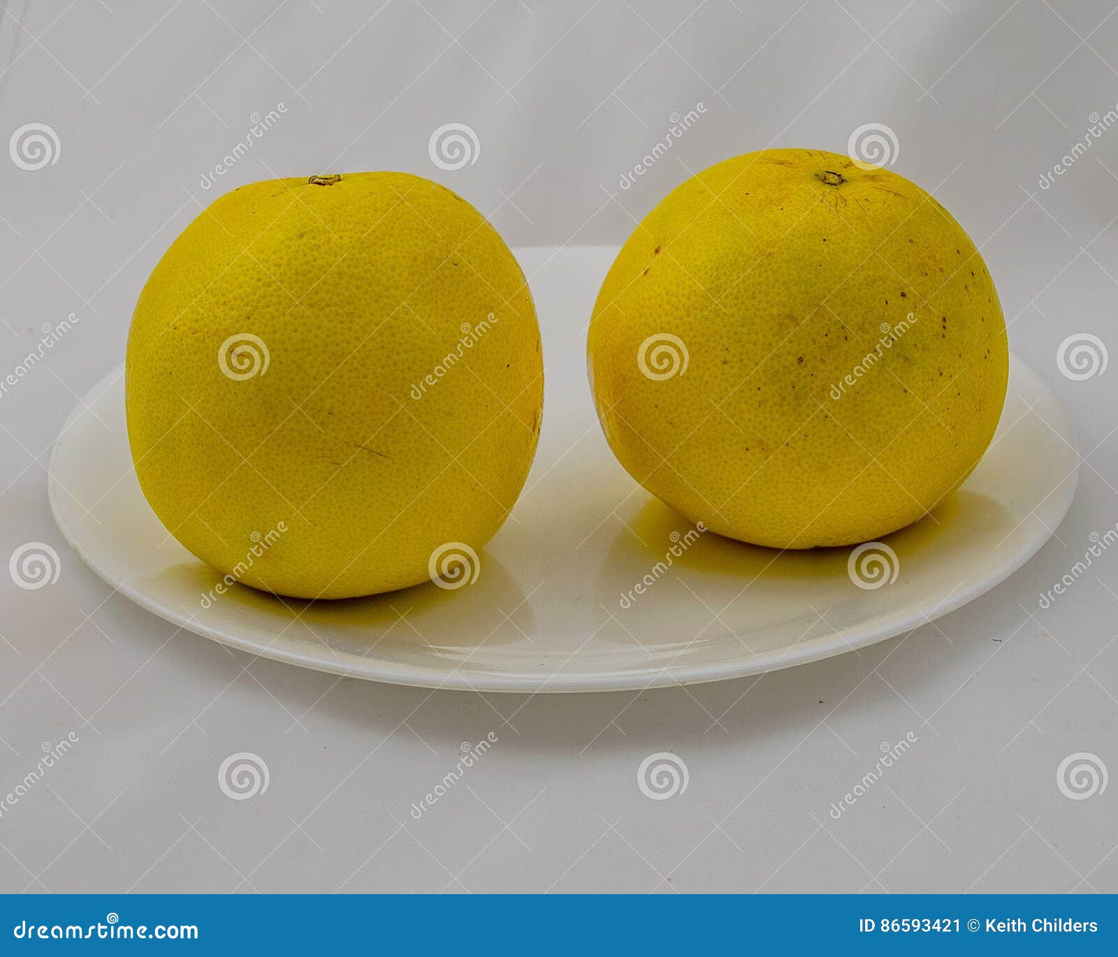 Two Grapefruits on a Plate stock image. Image of lone - 86593421