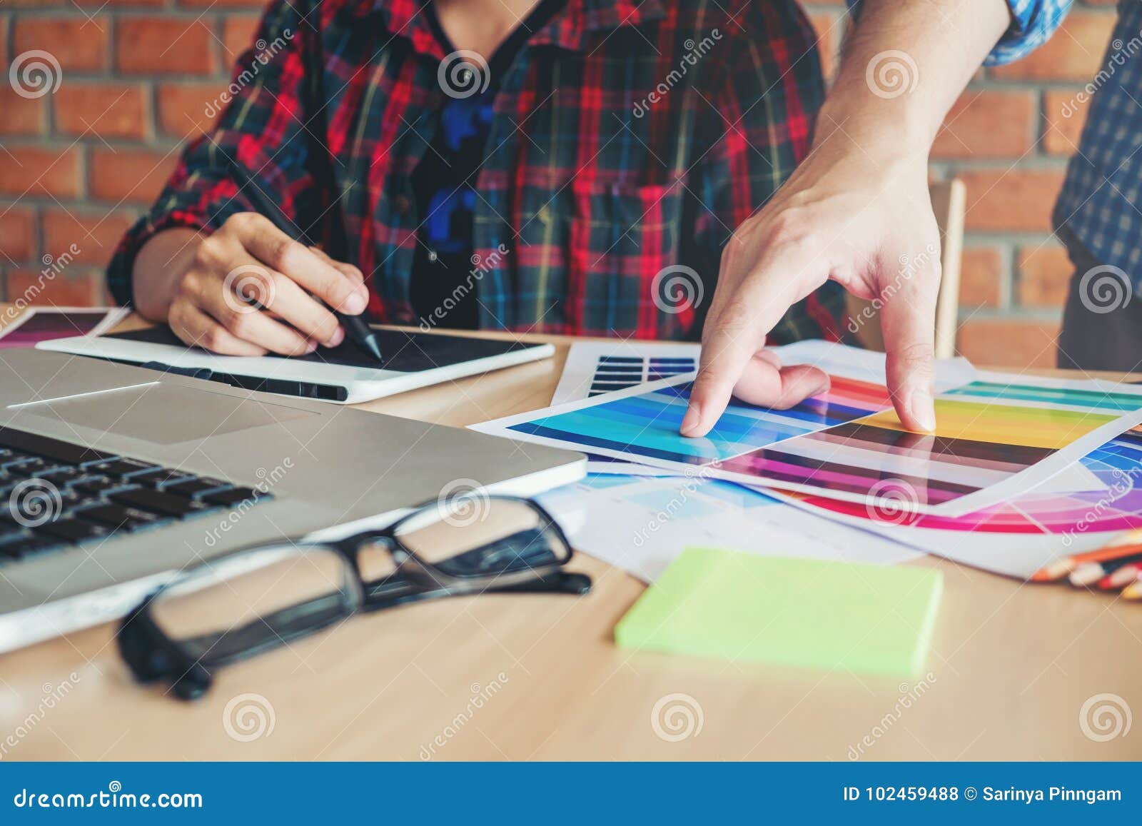 Two Graphic Designer Drawing on Graphics Tablet and Color Palette Guide ...