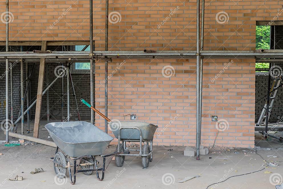 Wheelbarrows in Front of Red Brick Wall Stock Photo - Image of barrow ...