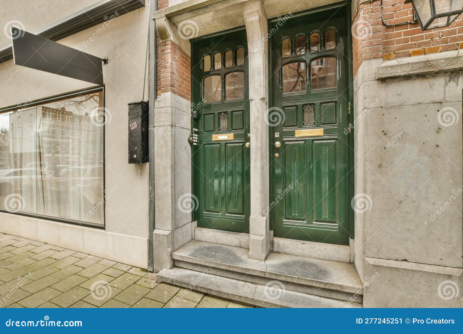 Two Green Doors on the Side of a Building Stock Image - Image of urban ...