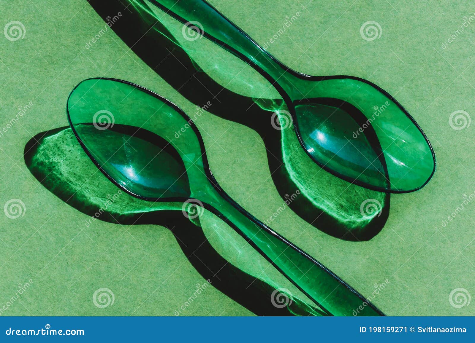 Two Green Transparent Plastic Spoons with Contrasting Shadows Stock ...