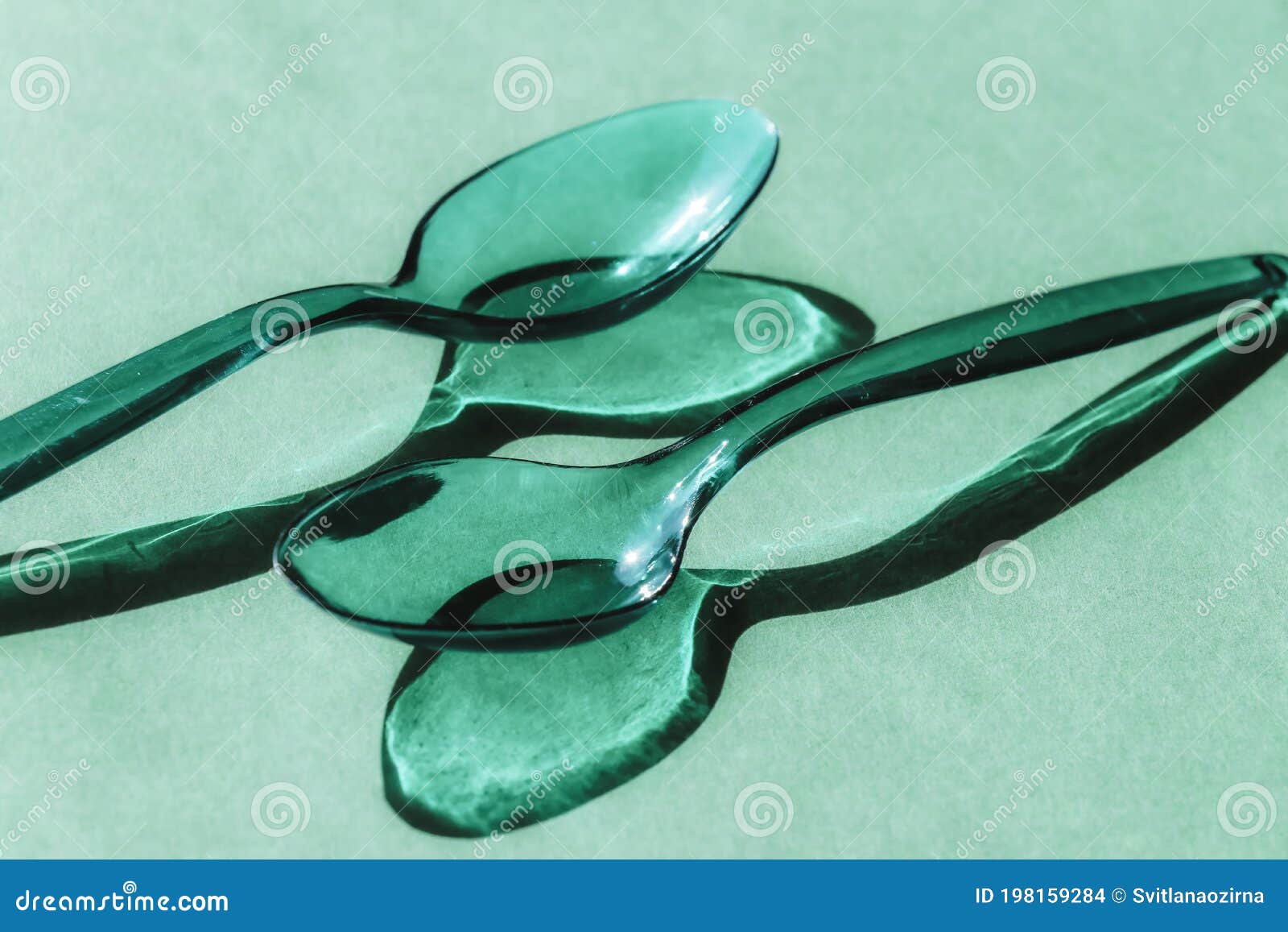 Two Green Transparent Plastic Spoons with Contrasting Shadows Stock ...