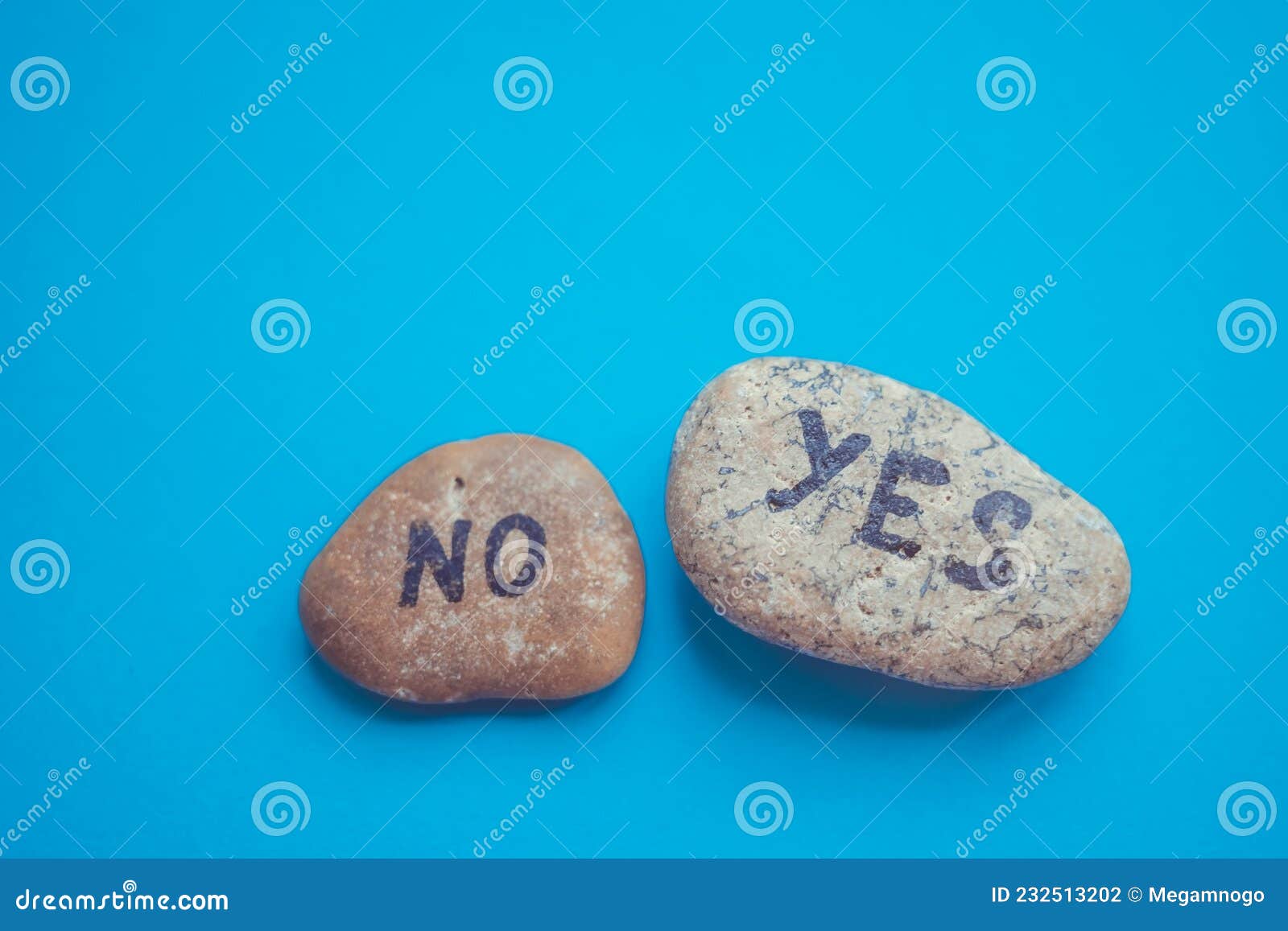 Two Grey Pebbles with the Text Yes and No on a Blue Table Stock Photo ...