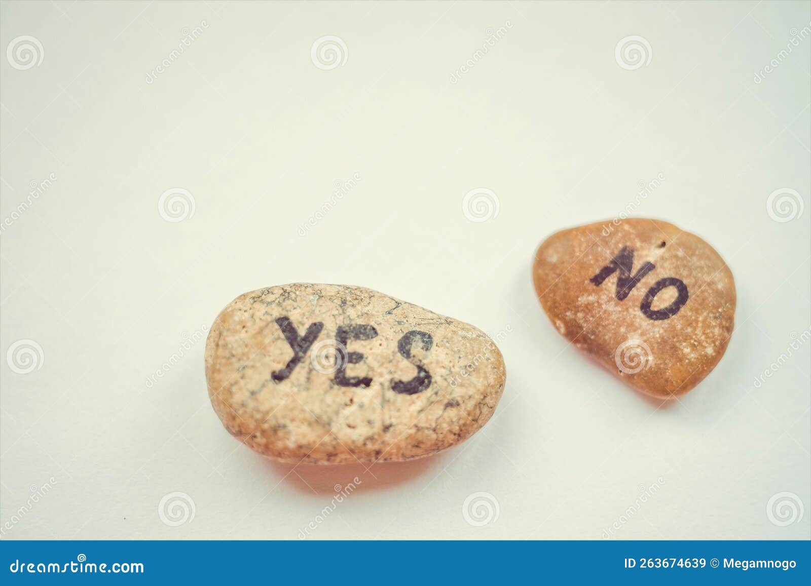Two Grey Pebbles with the Text Yes and No on a Blue Table Stock Image ...