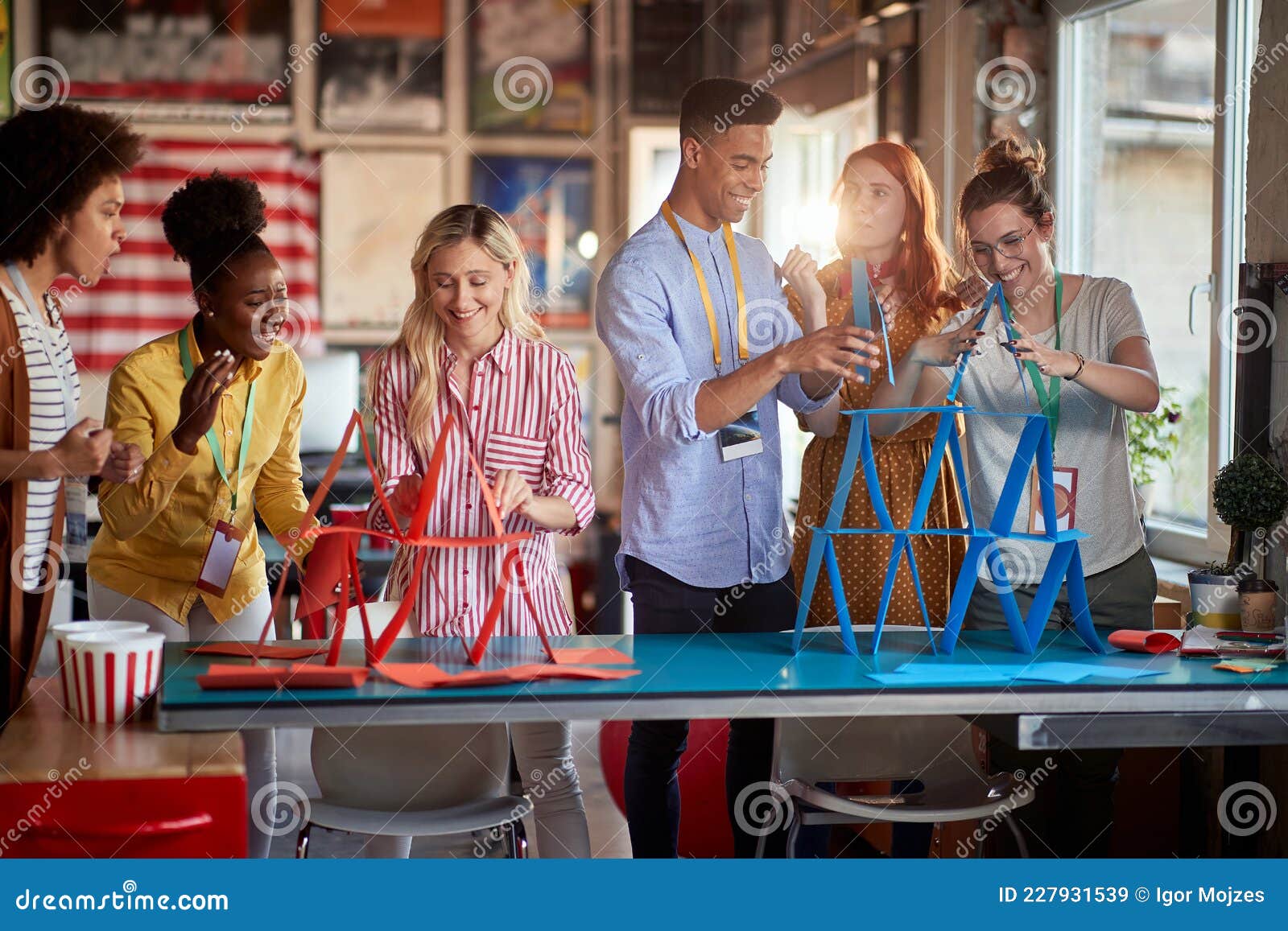 Two Group of Employees Making Paper Towers, Separated in Different ...