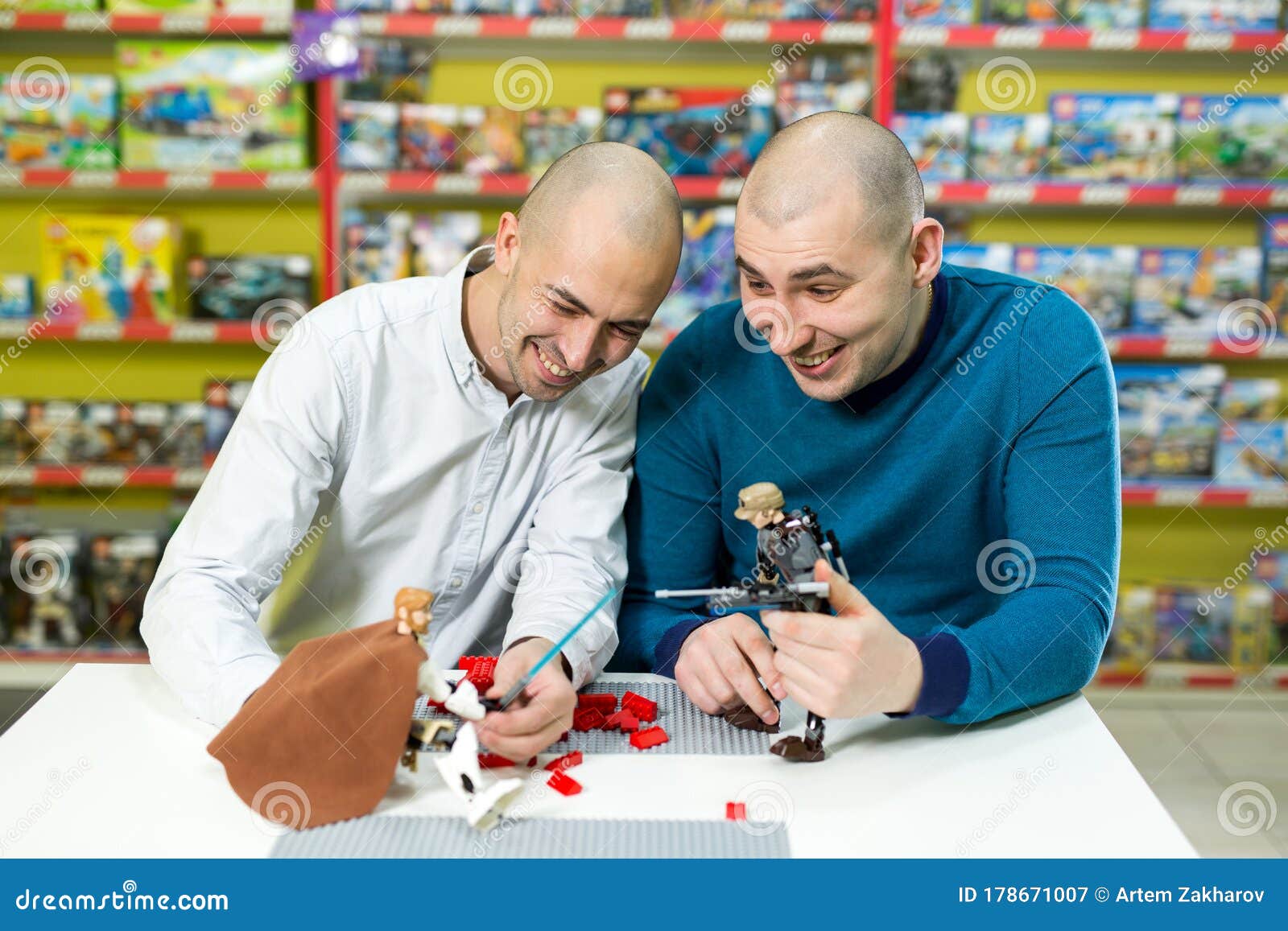 Two Grown Men Playing with Colored Plastic Blocks, Laughing. Stock ...