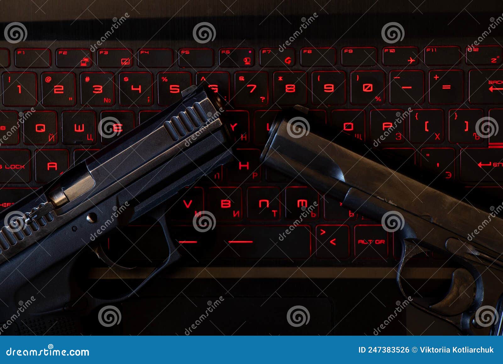 Two Guns Lie on a Black Laptop Keyboard with Red Backlight, Security ...