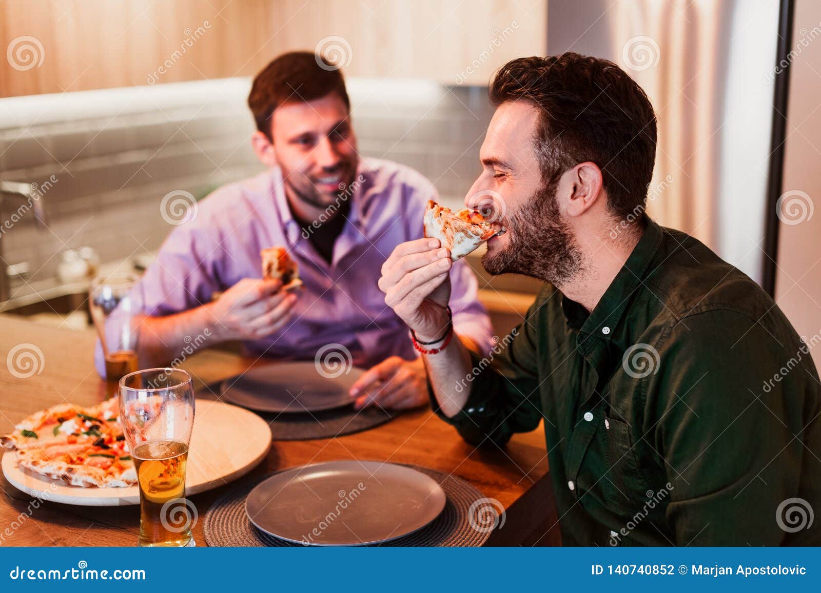 Two Guys Eating Pizza at Home Stock Photo - Image of handsome, indoor ...