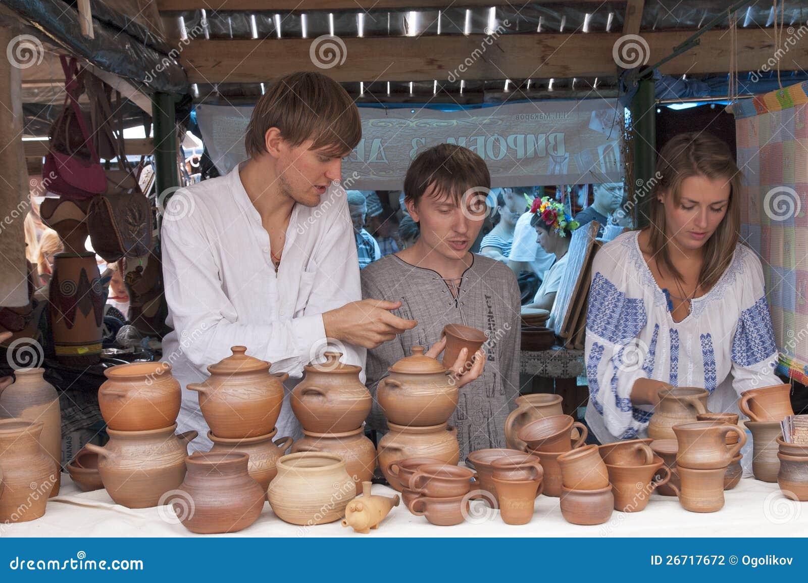 Two Guys and a Girl Selling Pottery. Editorial Photography - Image of ...