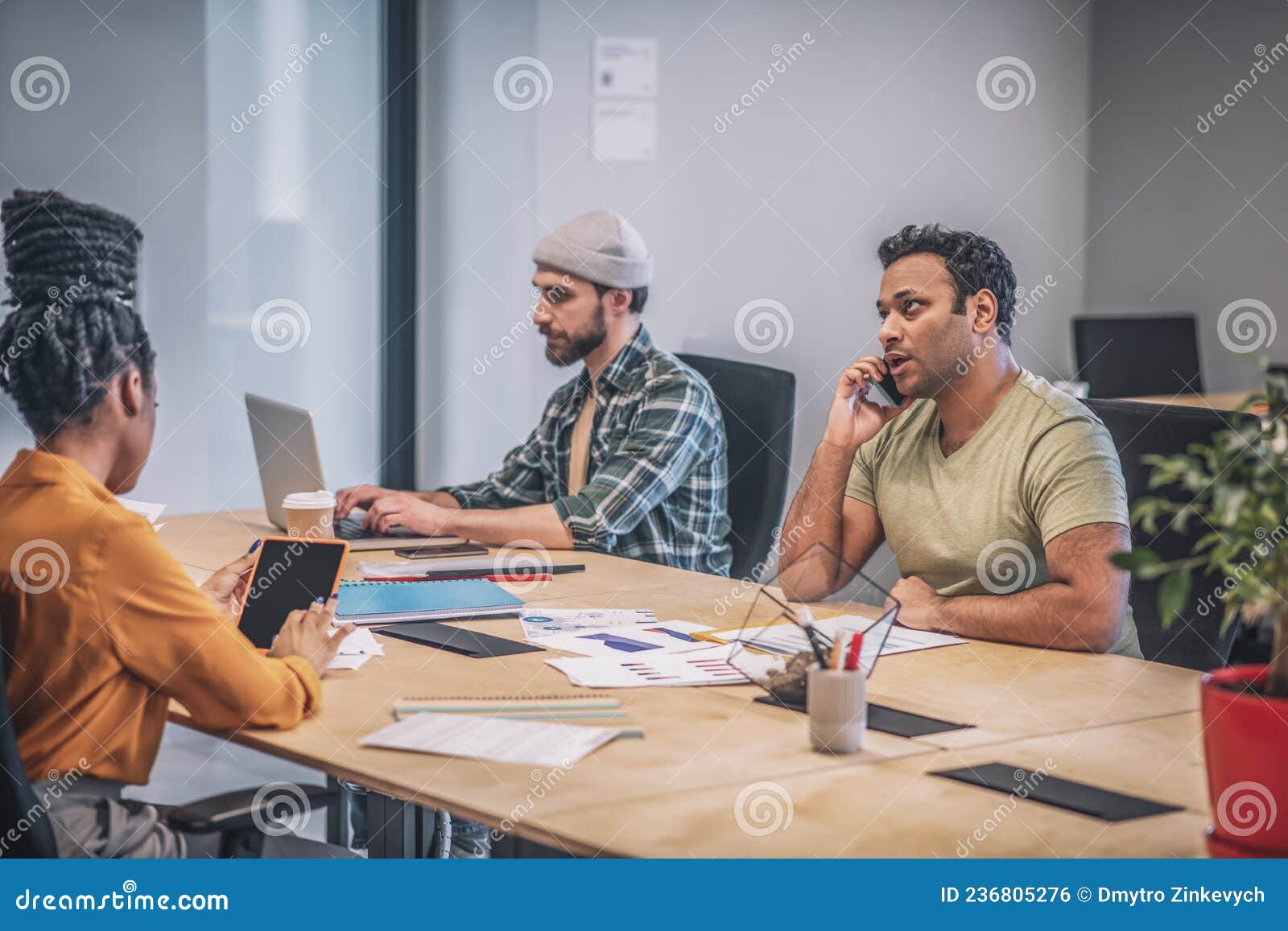 Two Guys and Girl Sitting at Common Table Stock Photo - Image of busy ...