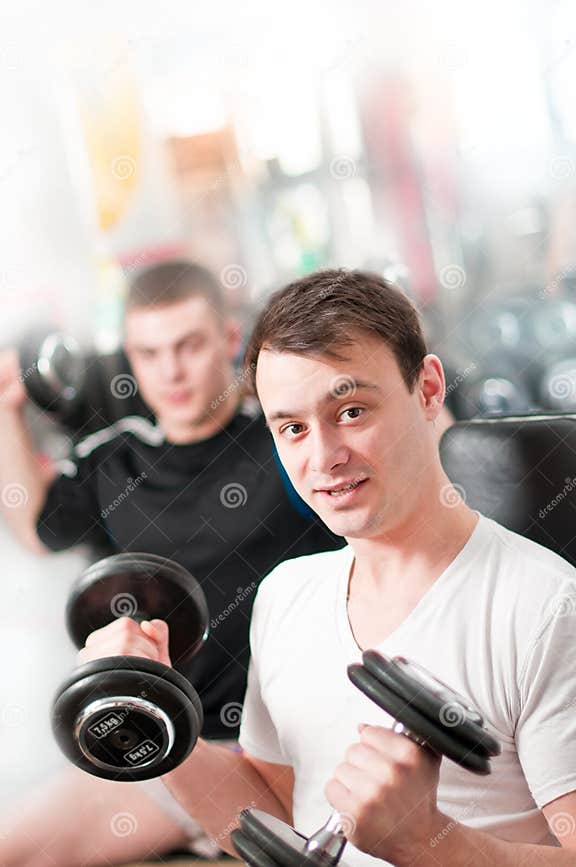 Two Guys Lifting Heavy Dumbbells Stock Image - Image of muscle, lifting ...