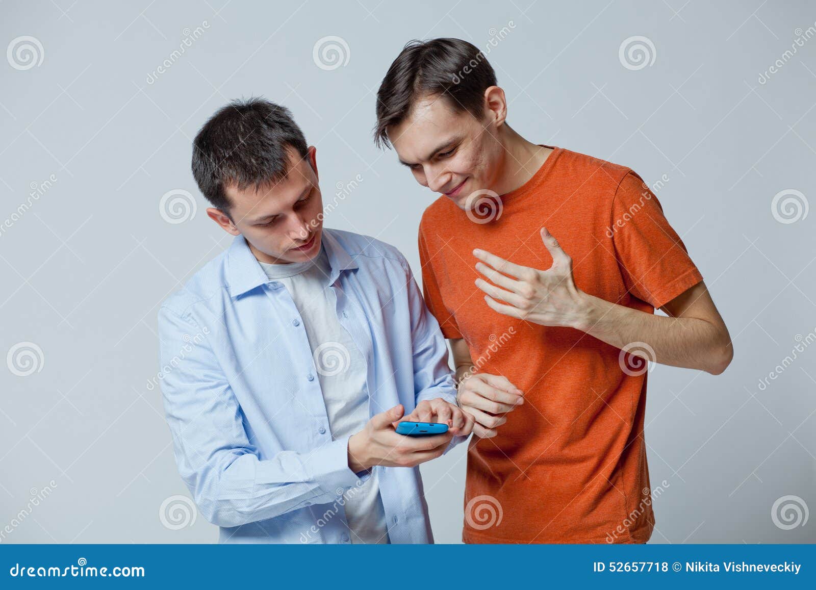 Two guys with the phone stock photo. Image of young, cellphone - 52657718
