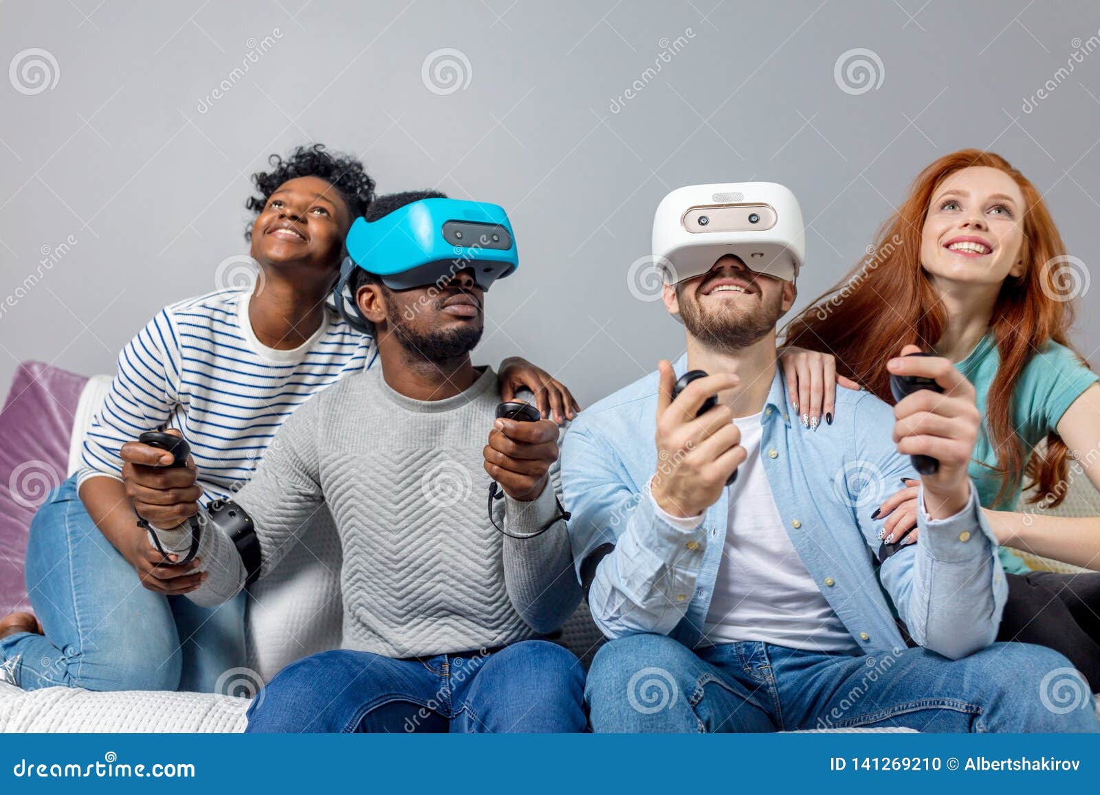 Two Guys Playing Video Games Using VR Glasses and Girlfriends Support ...
