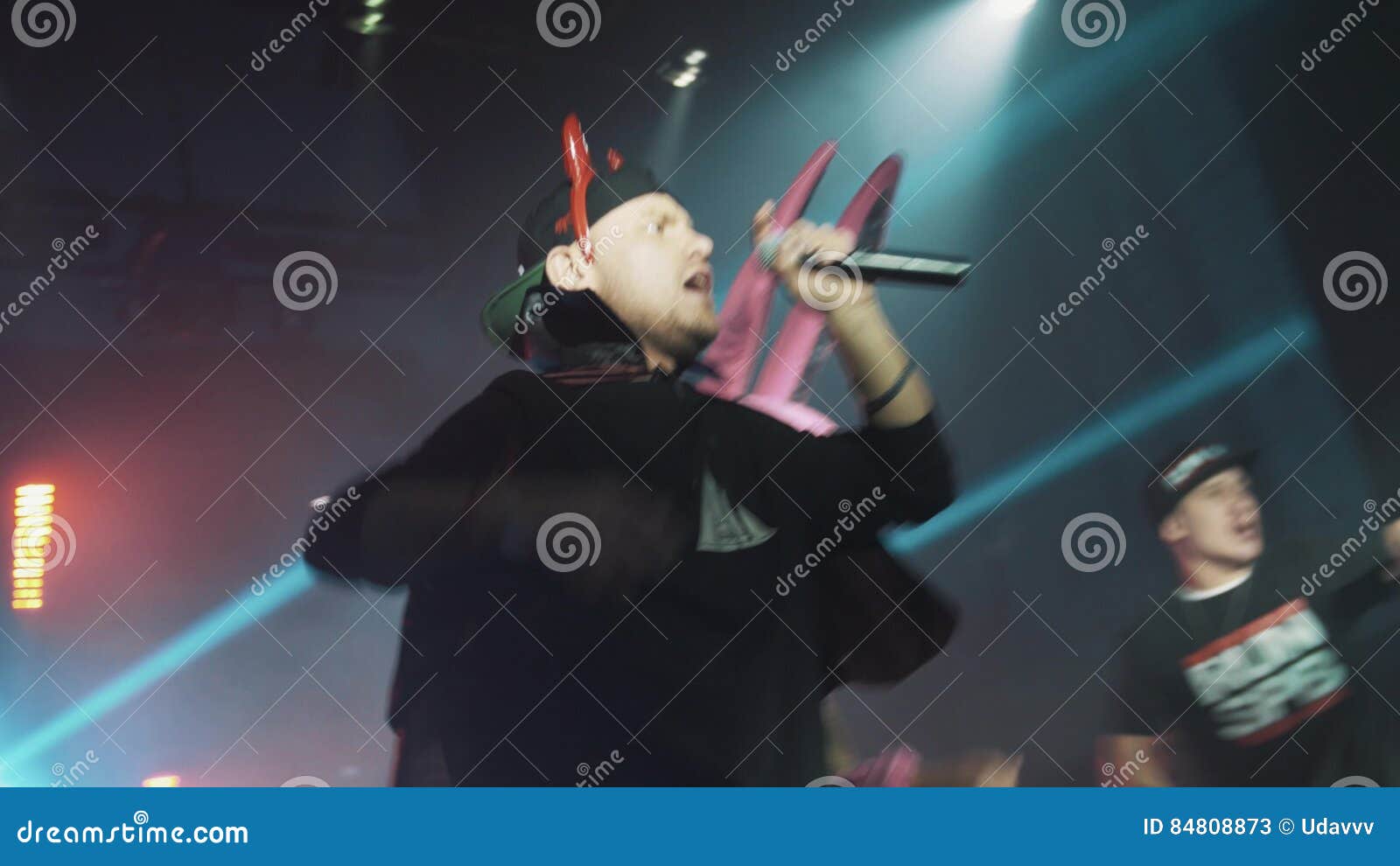 Two Guys Rapping and Cheering Crowd on Scene with Pink Rabbit Mascot ...