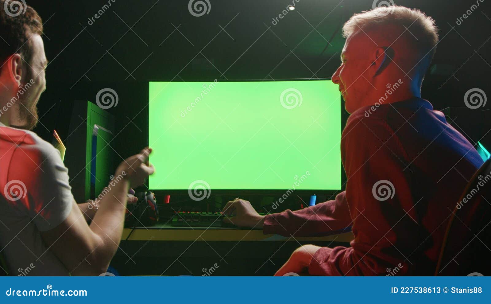 Two Guys are Sitting at a Computer and Looking at a Green Screen Stock ...