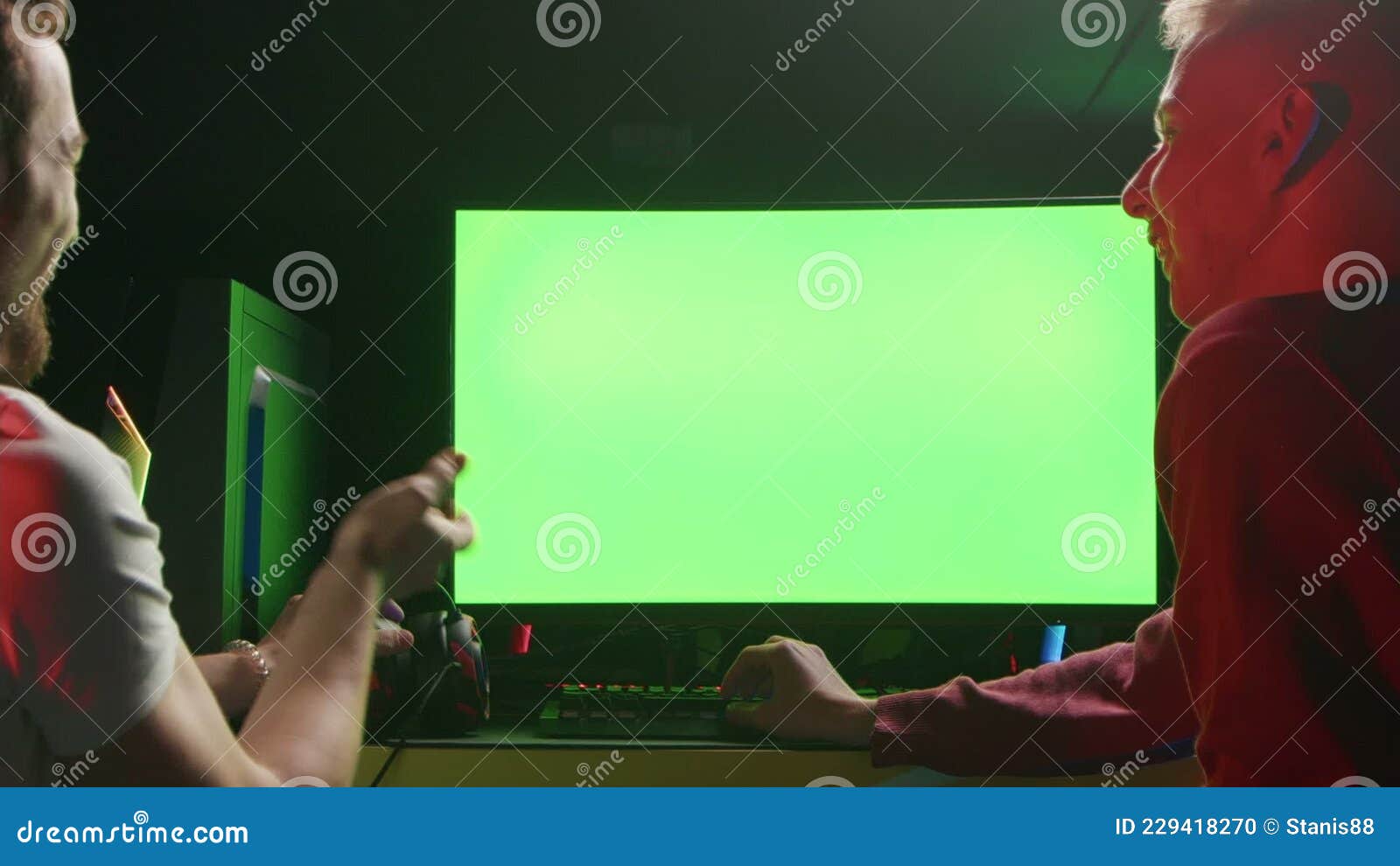 Two Guys are Sitting at a Computer and Looking at a Green Screen Stock ...