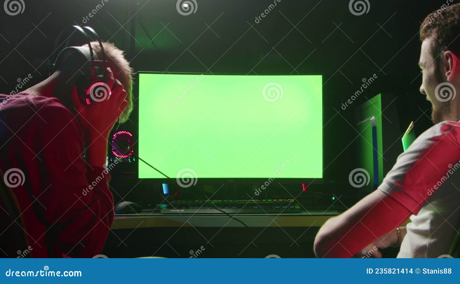 Two Guys are Sitting at a Computer and Looking at a Green Screen Stock ...