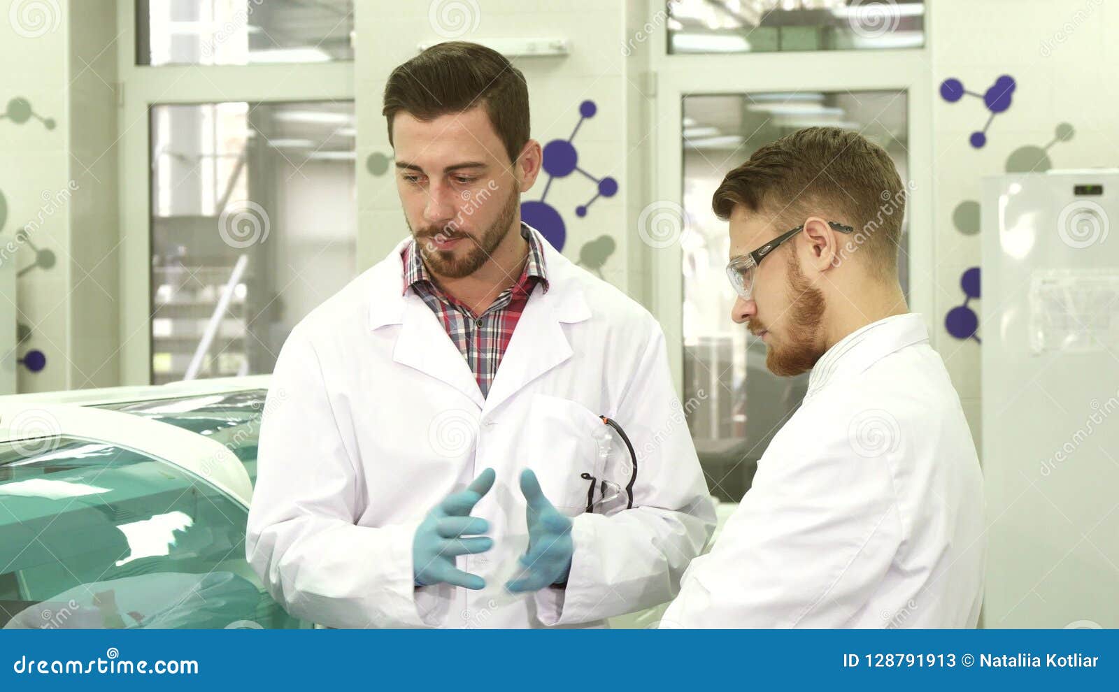 Two Young Laboratory Assistants Discuss the Nuances of Their Workflow ...