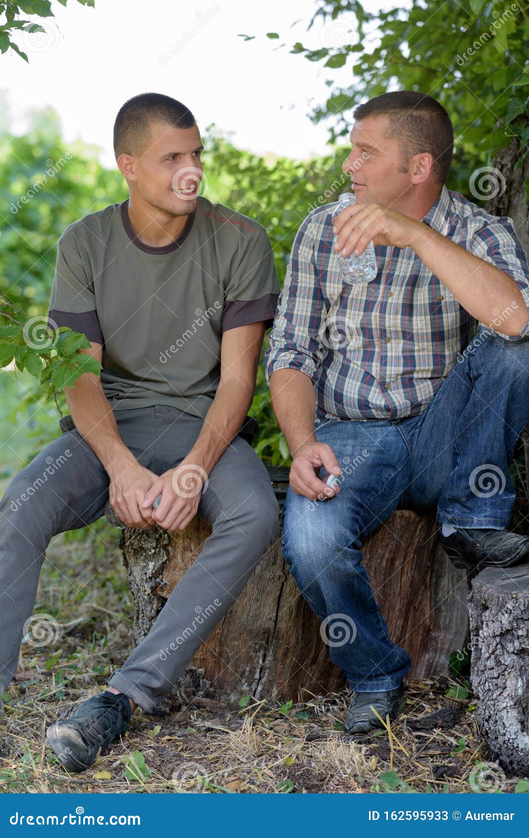 Two guys talking in forest stock image. Image of hatchet - 162595933