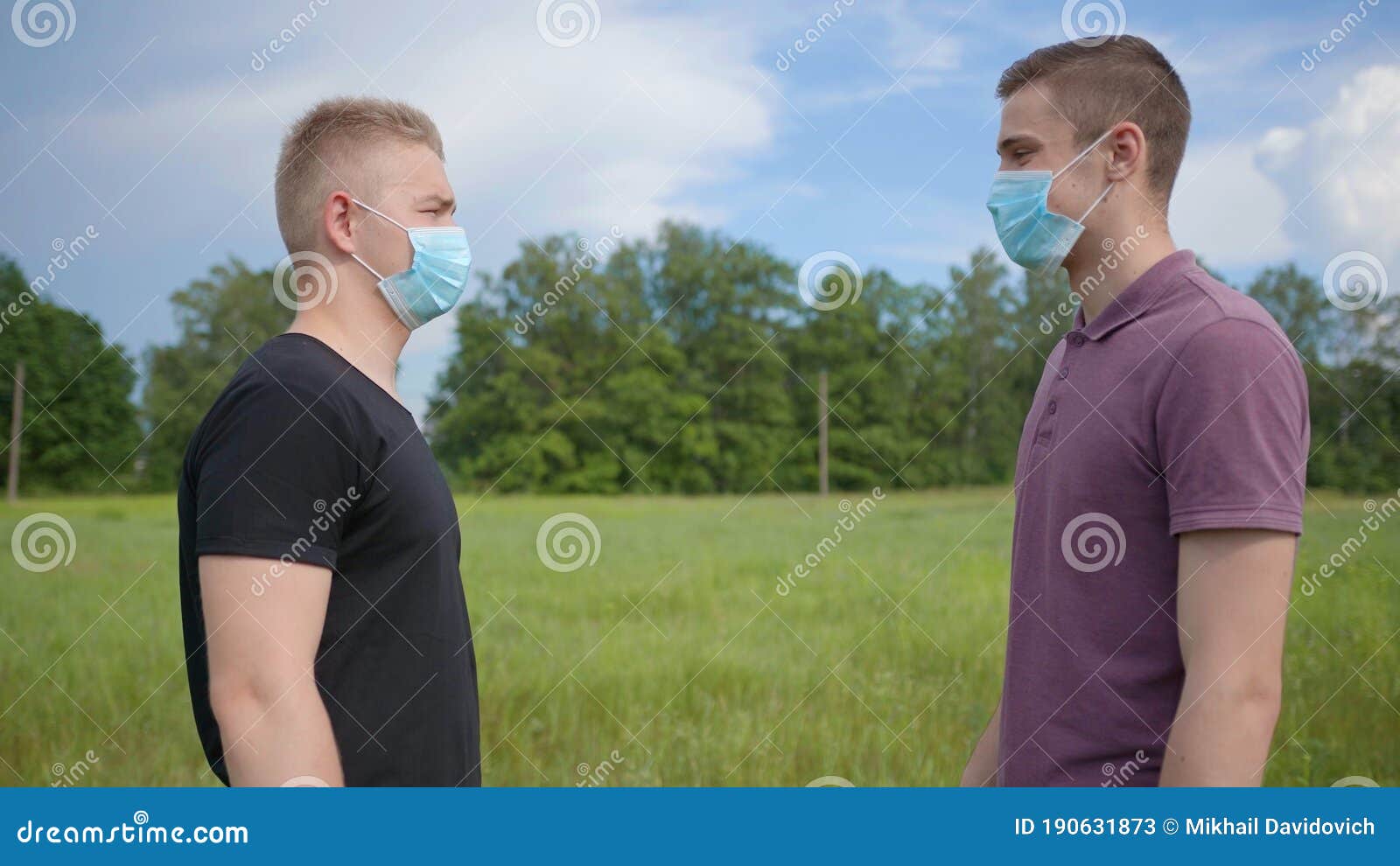 Two Guys are Talking in Masks in the Park. Pandemic Concept. Stock ...