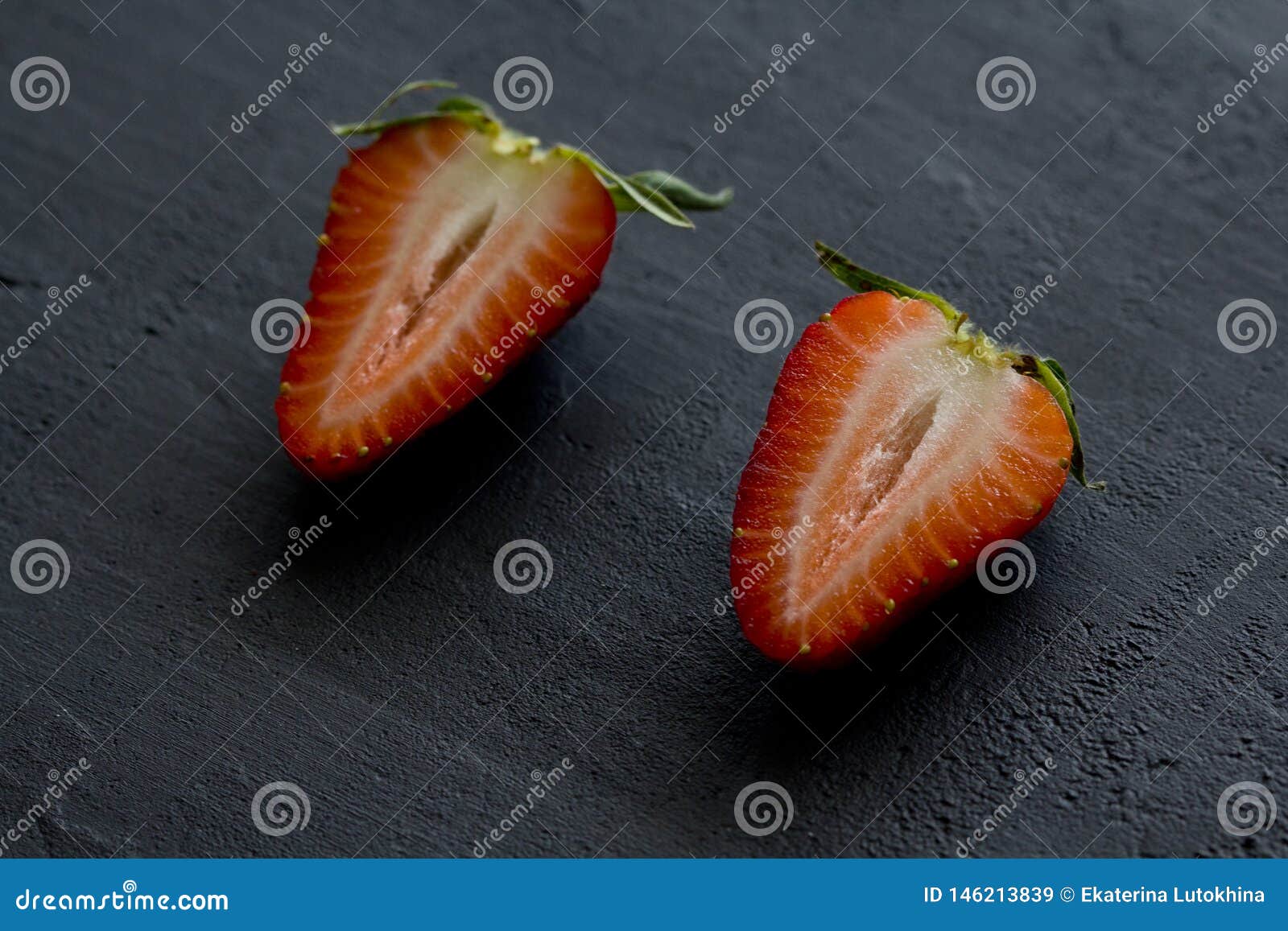 Two Half Strawberries Cut Red Beautiful Strawberries Close Up On A Black Dark Concrete