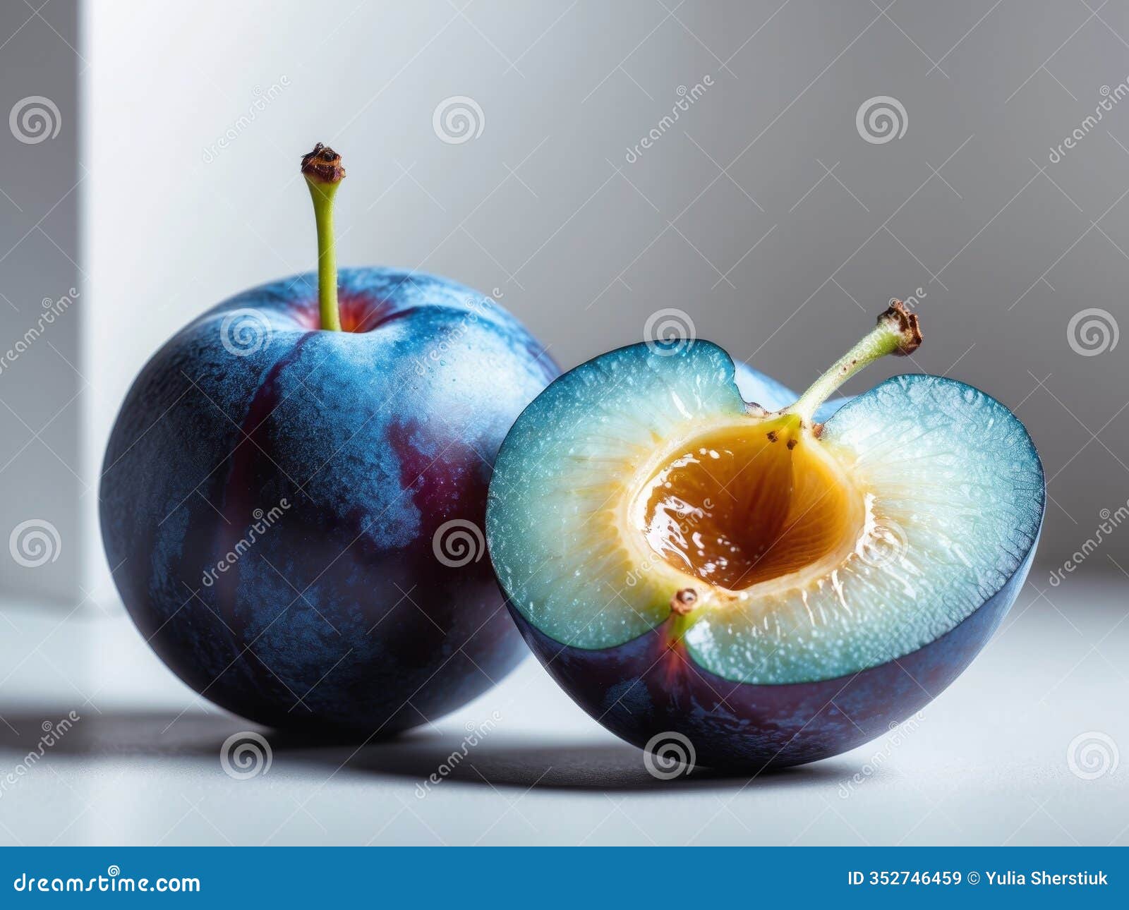 Two Halves of a Blue Plum Showcasing Its Interior Stock Image - Image ...