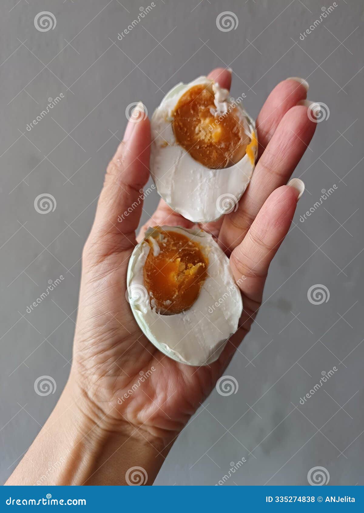 Two Halves of Salted Egg Held by Someone& X27;s Hand Stock Photo ...