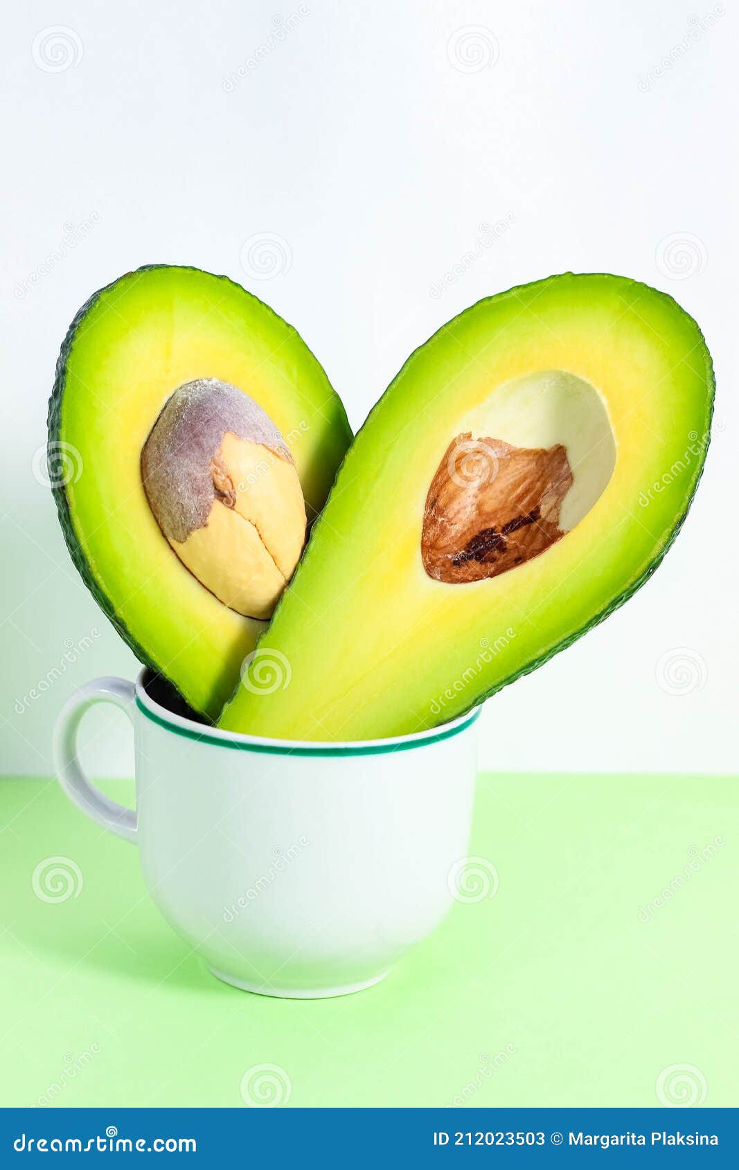 Two Halves of a Sliced Avocado Stand Vertically in a Mug Stock Image ...