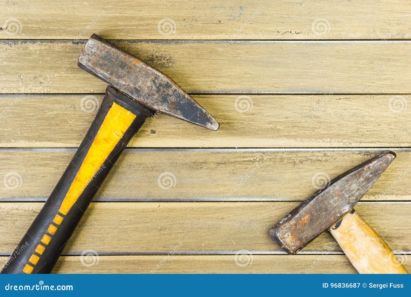 Two Hammers on a Yellow Iron Background. Background. Stock Image ...