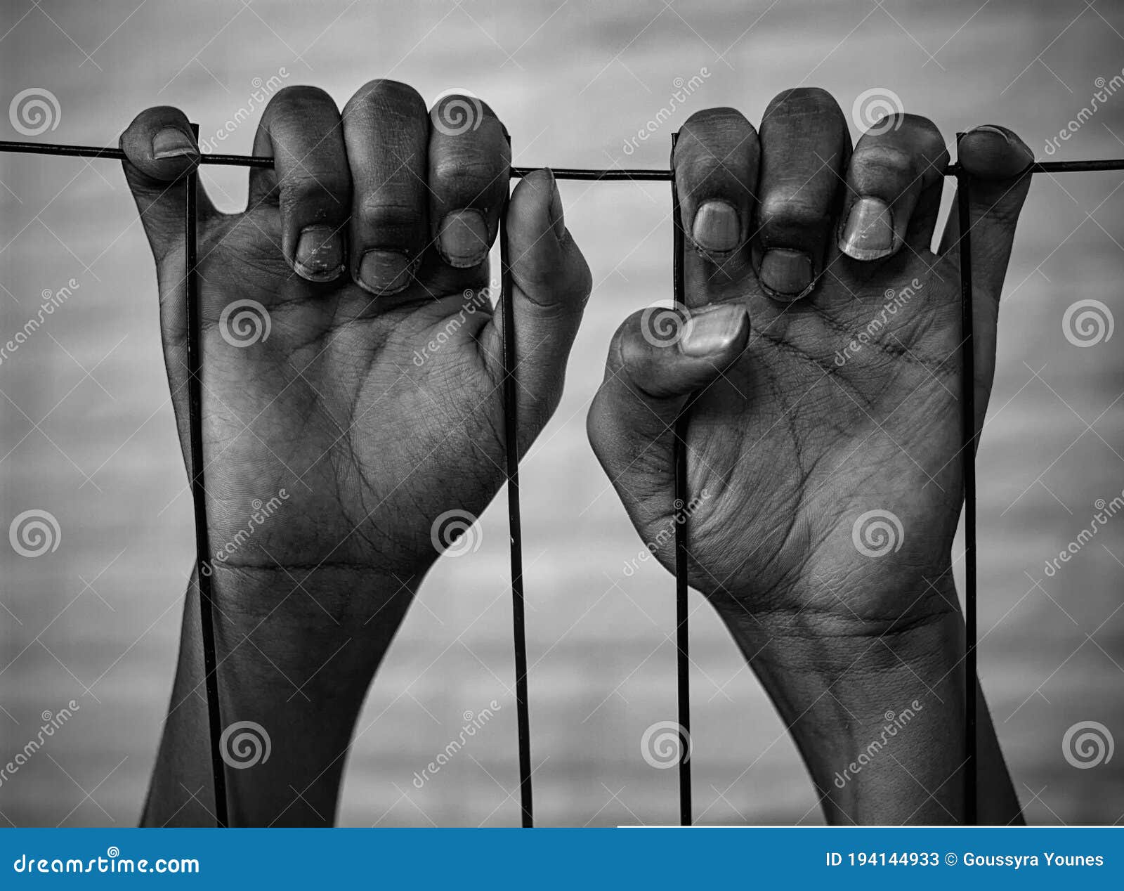 Two hands behind the bars stock image. Image of footwear - 194144933