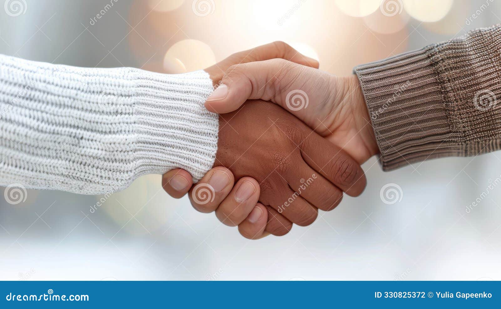 Handshake between Two People in Cozy Sweaters on a Soft Blurred ...