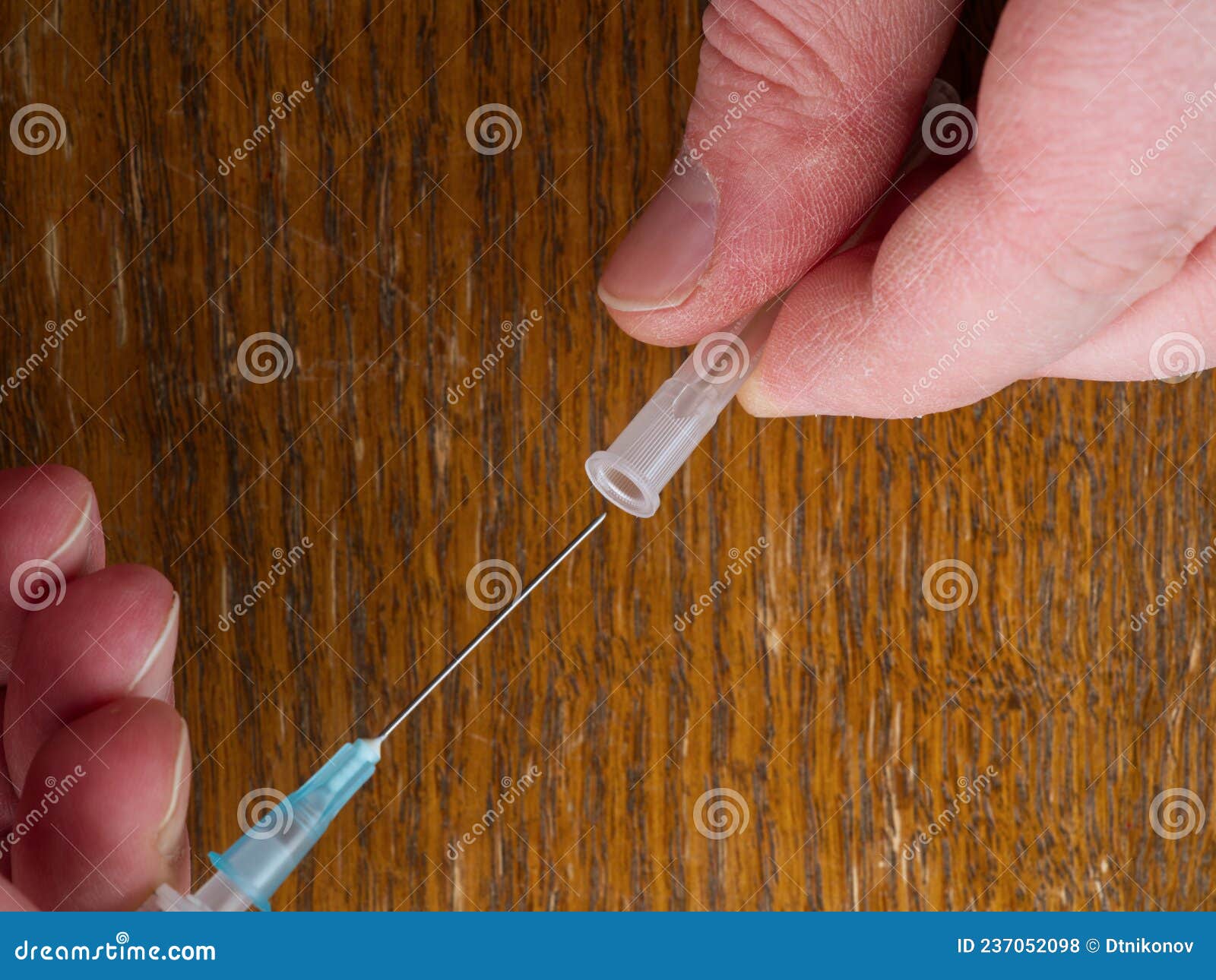 Two Hands Close the Needle of the Syringe. Stock Photo - Image of ...