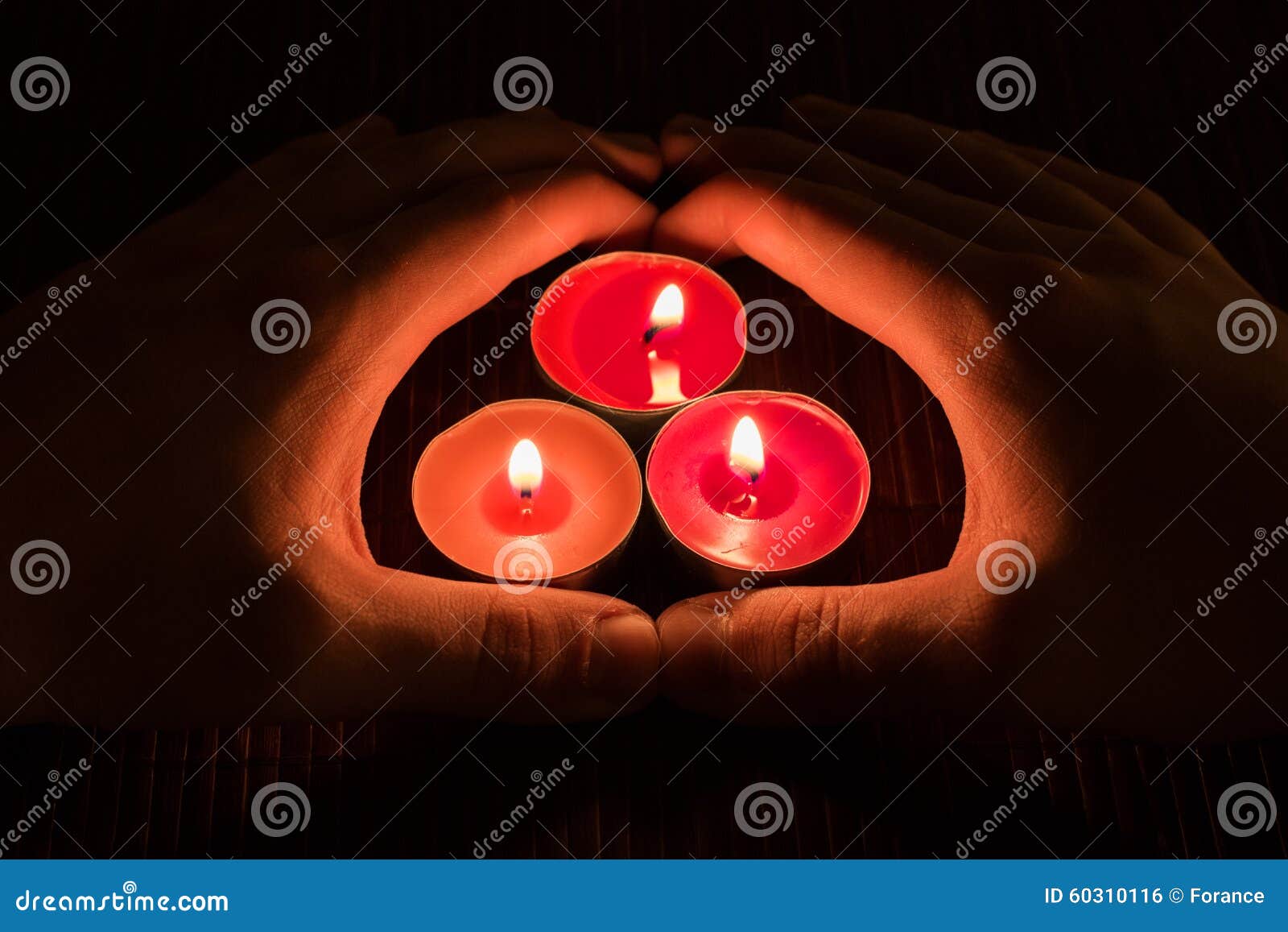 Two Hands Covering Three Burning Candles Stock Photo - Image of hand ...