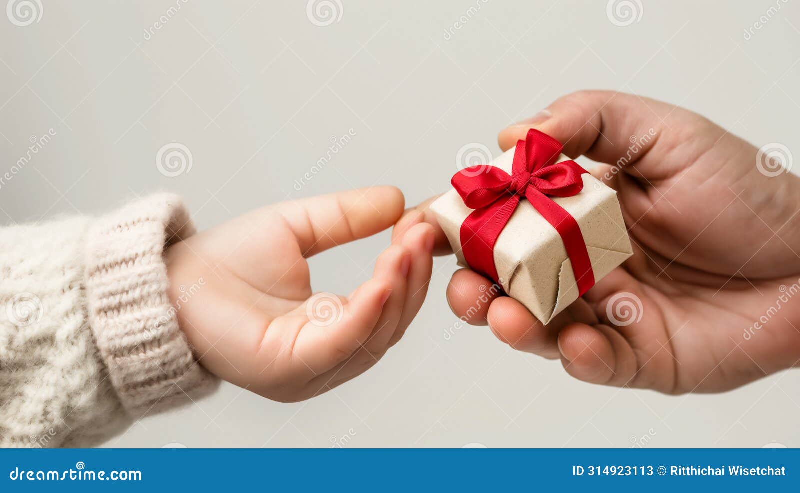 Two Hands Exchanging a Small Gift Box with a Red Ribbon Stock ...
